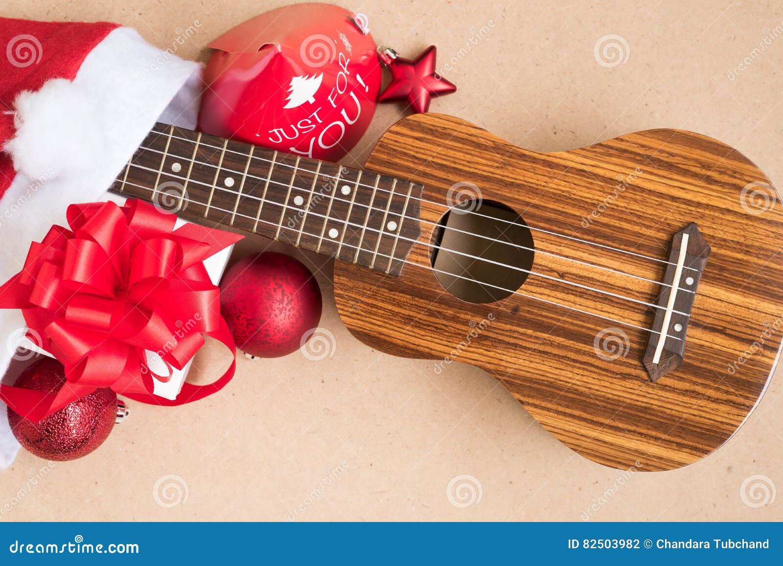 Ukulele with Christmas Baubles and Gift Box Inside Santa Hat Stock ...