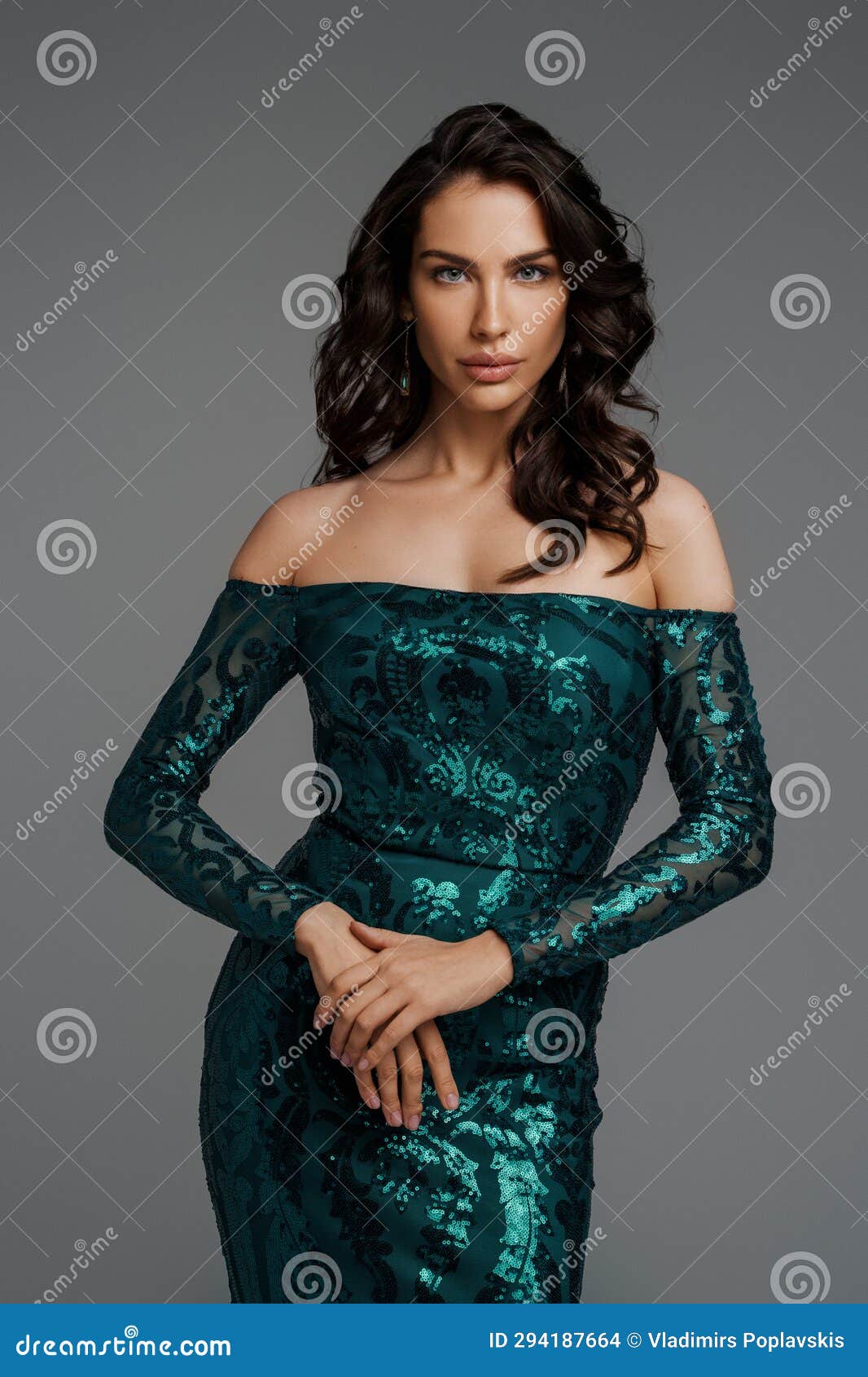 Uma Morena Maravilhosa De Um Vestido Verde Da Noite Cinza Contra Um