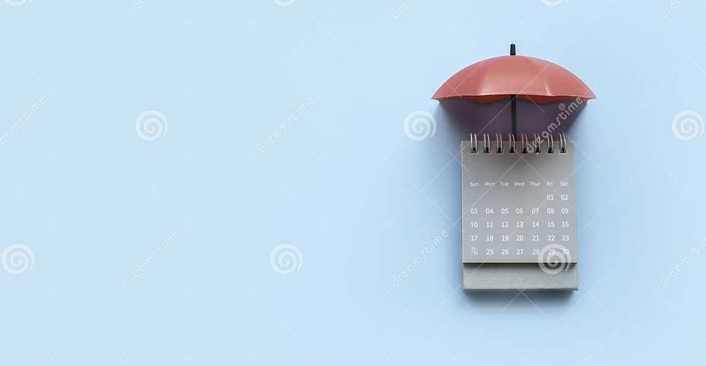 Umbrella Over a Calendar on a Blue Background Stock Photo - Image of ...
