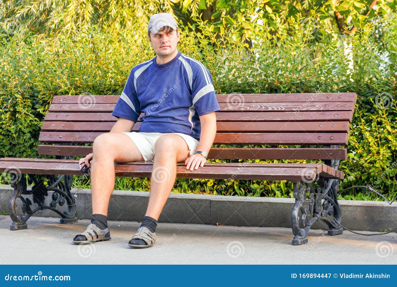 Un Joven Está Sentado Solo En Una Banca Del Parque Imagen de archivo ... Un Joven Está Sentado Solo En Una Banca Del Parque Imagen de archivo ...