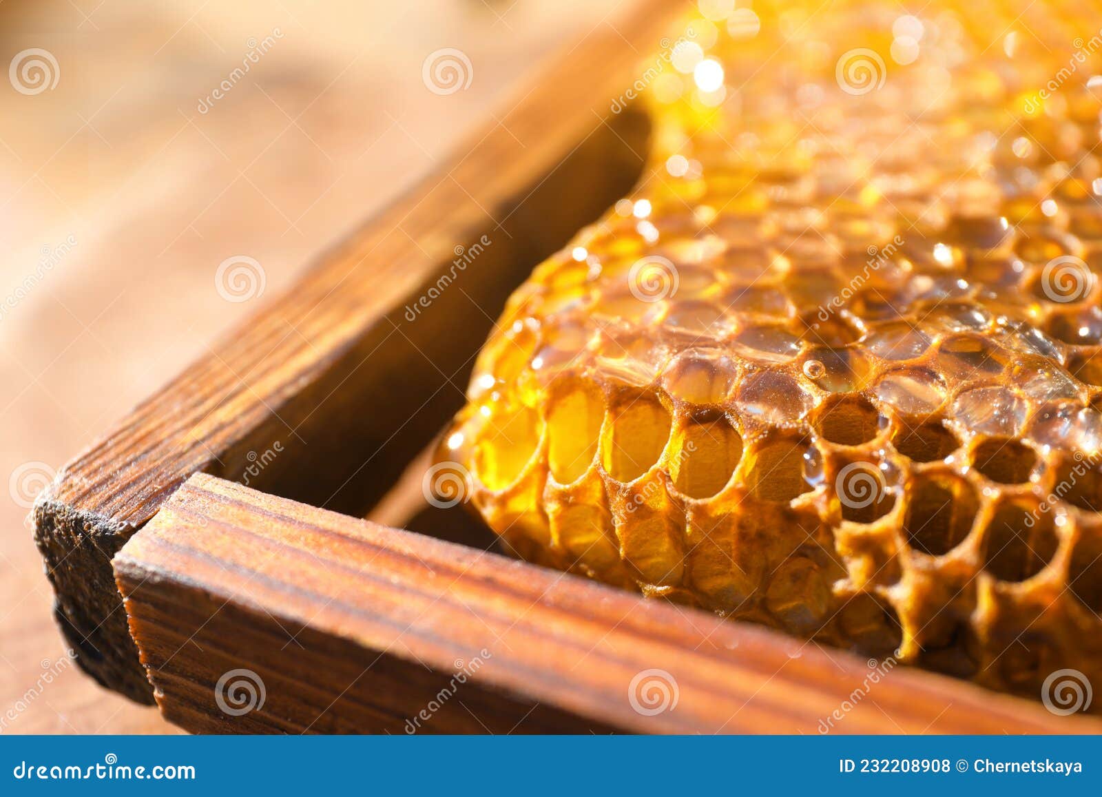 Uncapped Honeycomb Frame on Blurred Background, Closeup Stock Photo ...