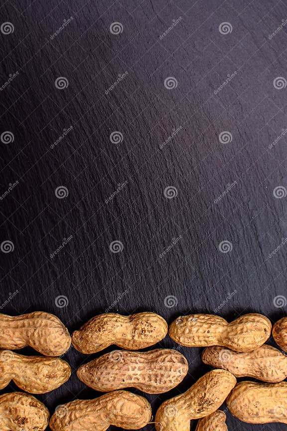 Unclean Peanuts Lie on a Black Stone Board in the Form of a Frame ...