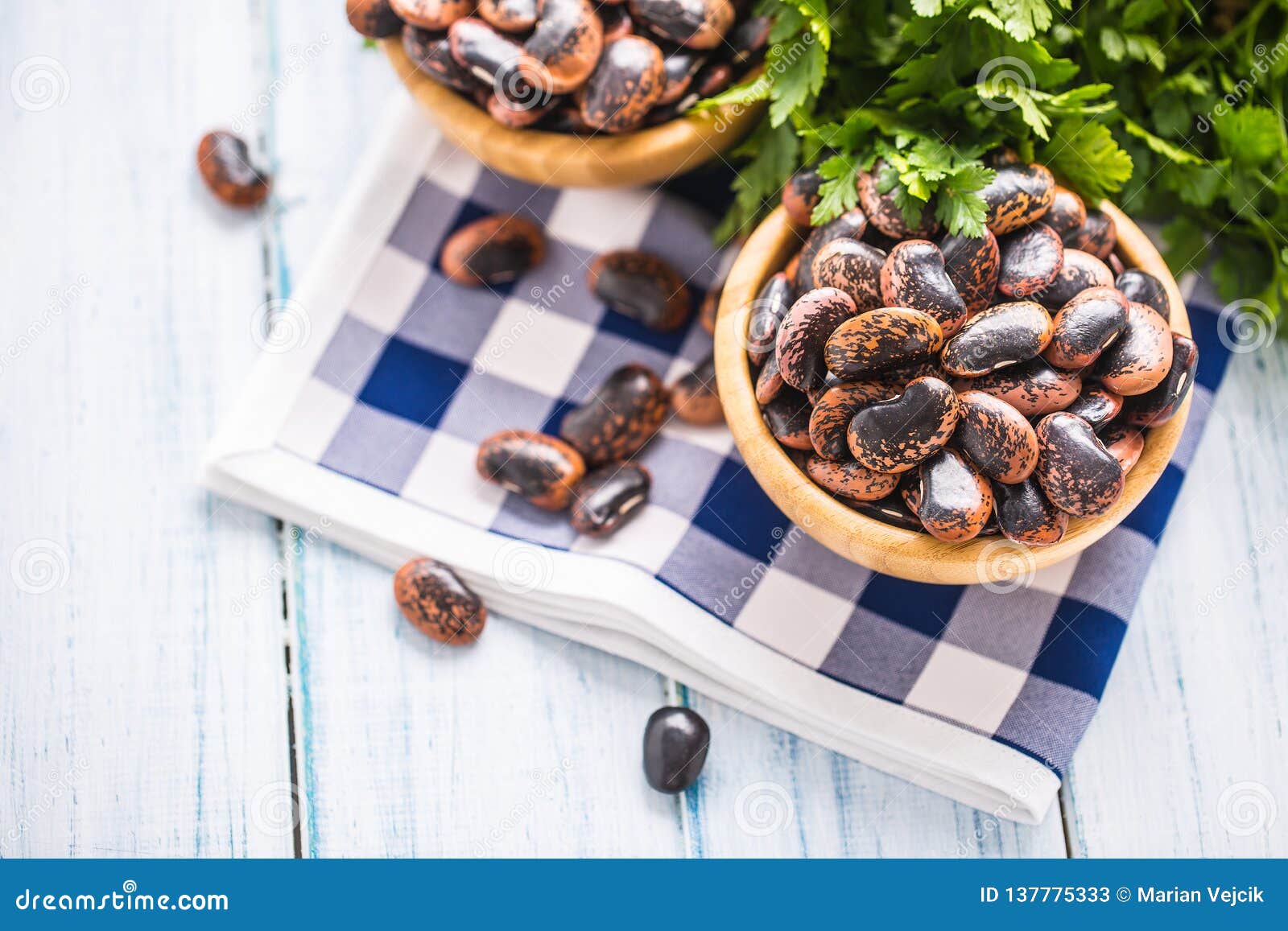 Uncooked Beans in Wooden Bowles with Parsley Herbs on Kitchen Table ...