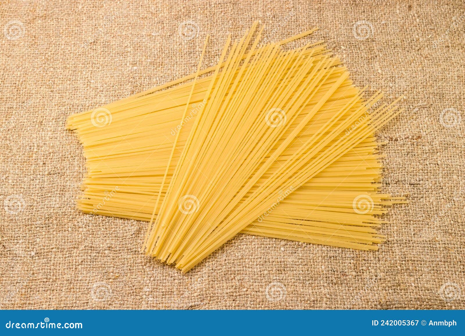 Uncooked Long Round Pasta on a Burlap Surface Stock Image - Image of ...