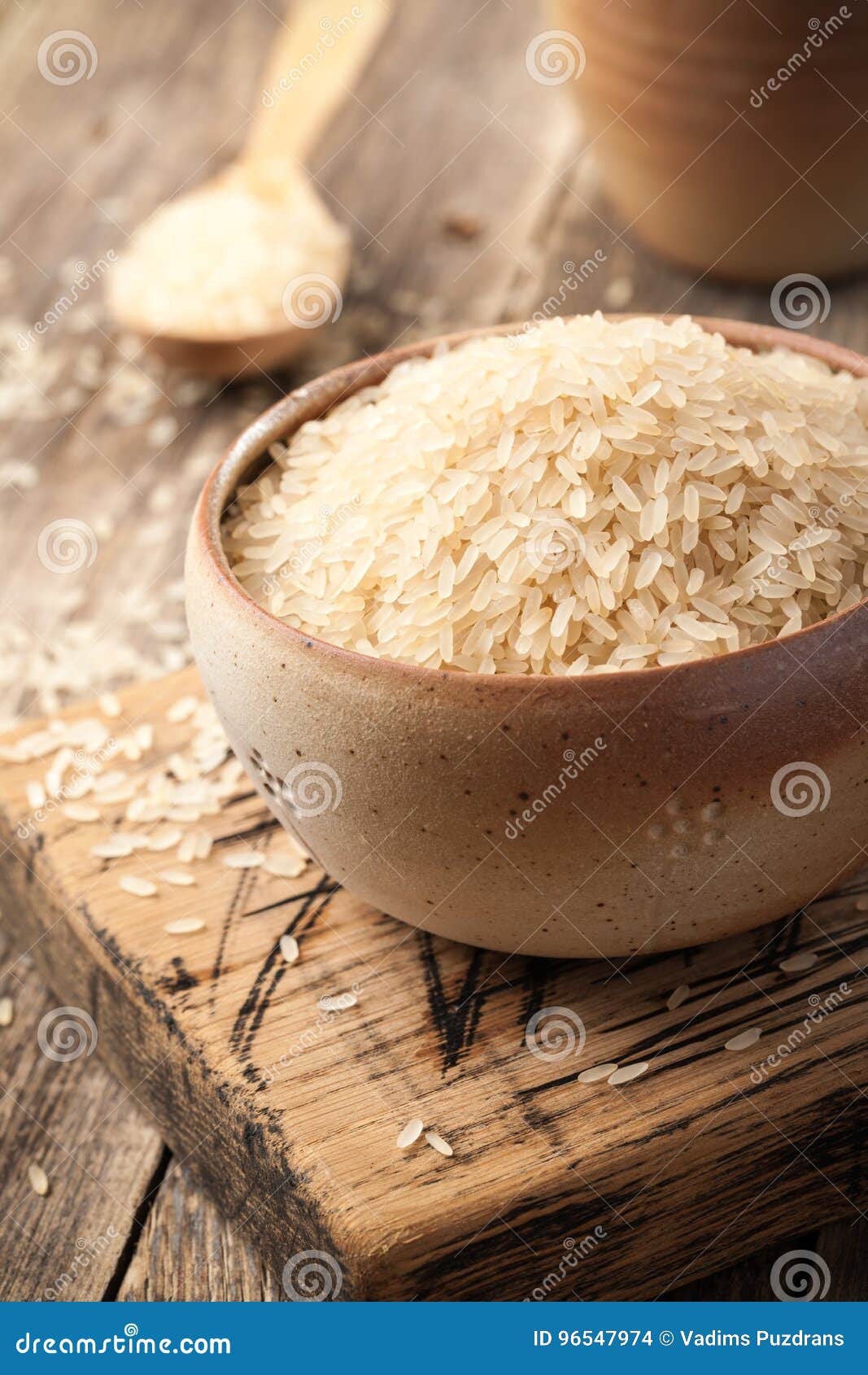 Uncooked Parboiled Rice in a Bowl on Wooden Table Stock Photo - Image ...