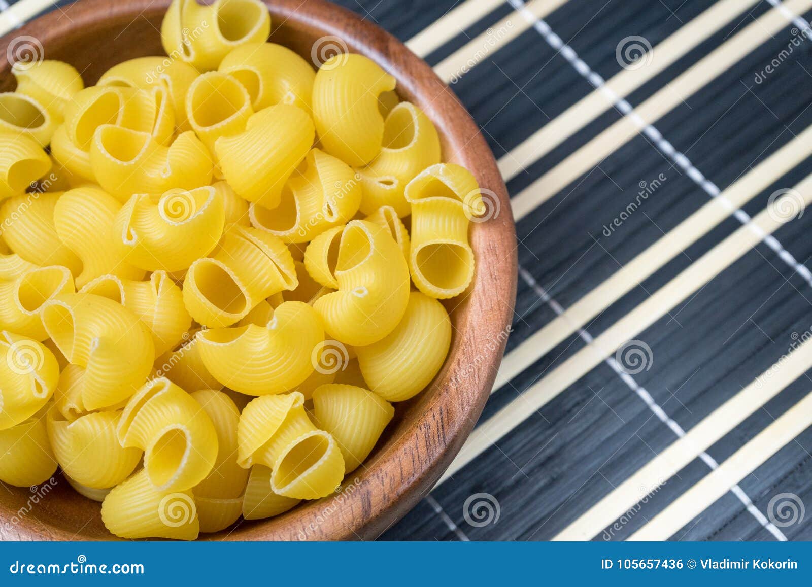 Uncooked Pasta in Wooden Bowl. Preparation for Cooking Stock Photo ...