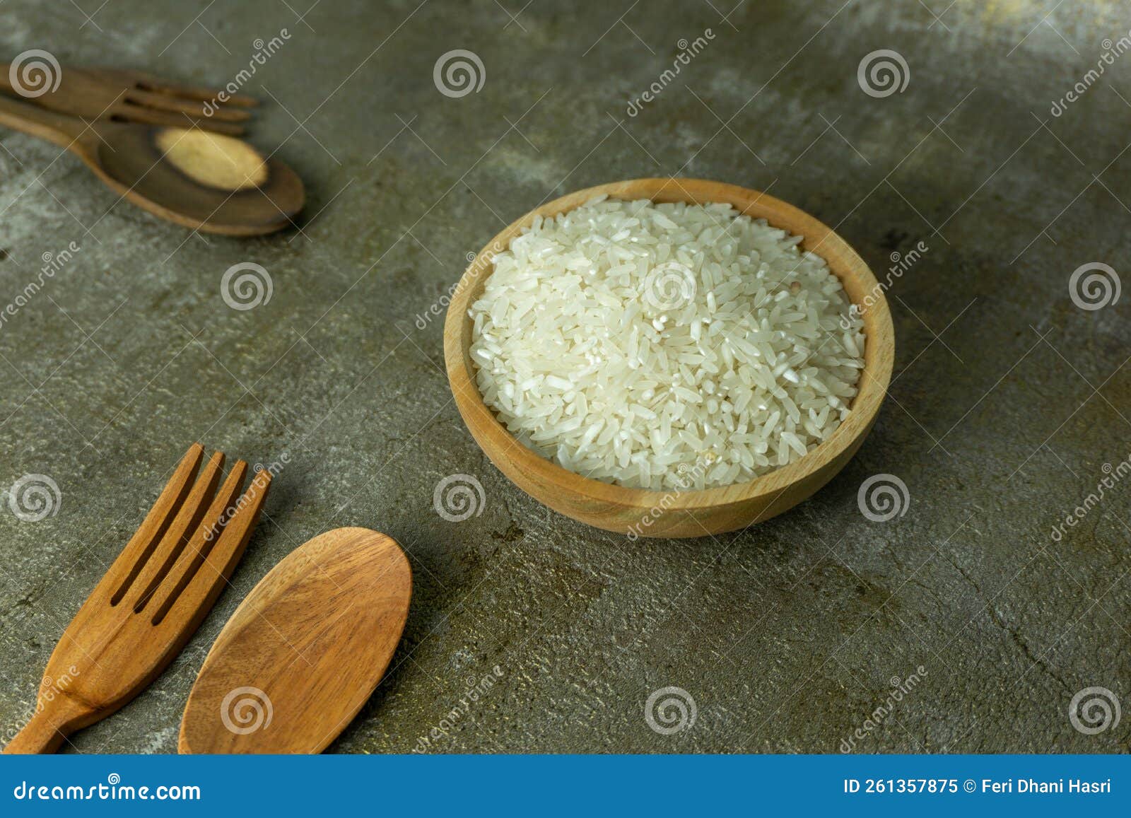 Uncooked Rice or Dry Rice. Raw Rice in Wooden Bowl with Wooden Spoon ...