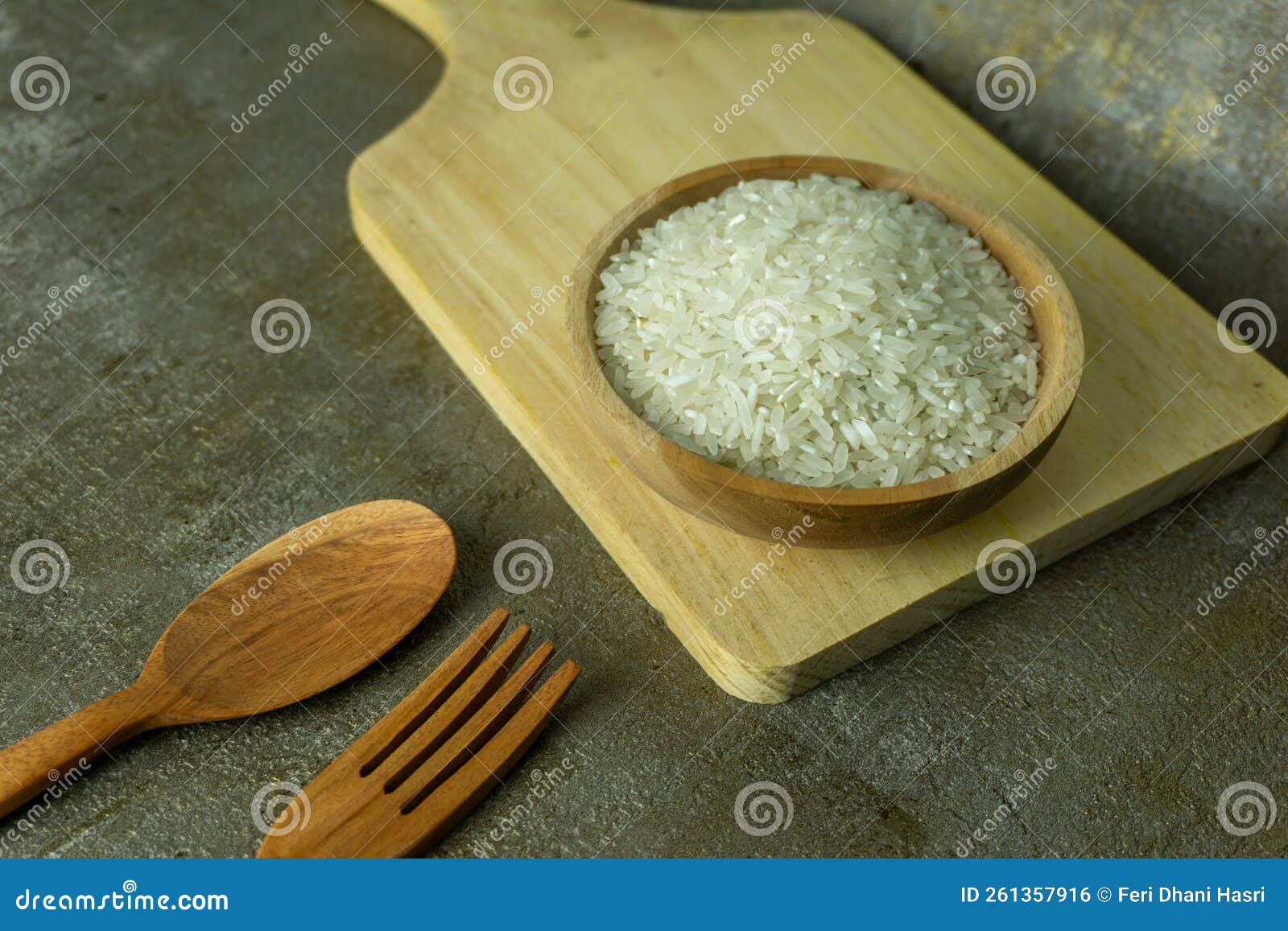 Uncooked Rice or Dry Rice. Raw Rice in Wooden Bowl with Wooden Spoon ...