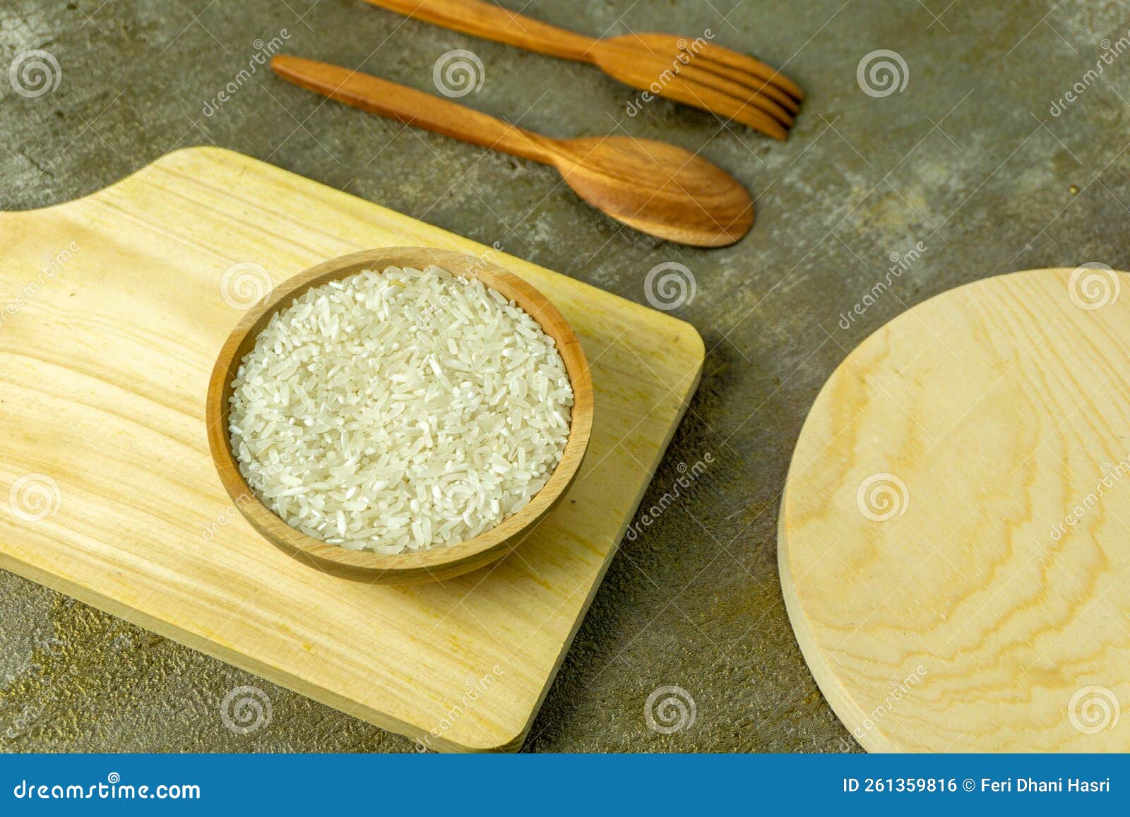 Uncooked Rice or Dry Rice. Raw Rice in Wooden Bowl with Wooden Spoon ...