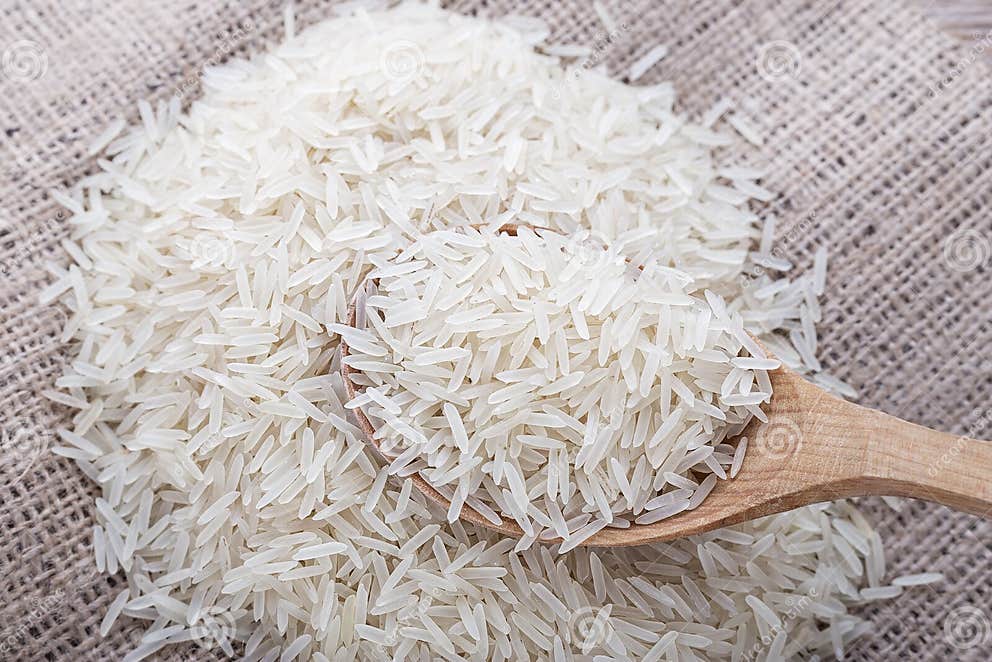 Uncooked rice is scattered stock image. Image of detail - 91972365