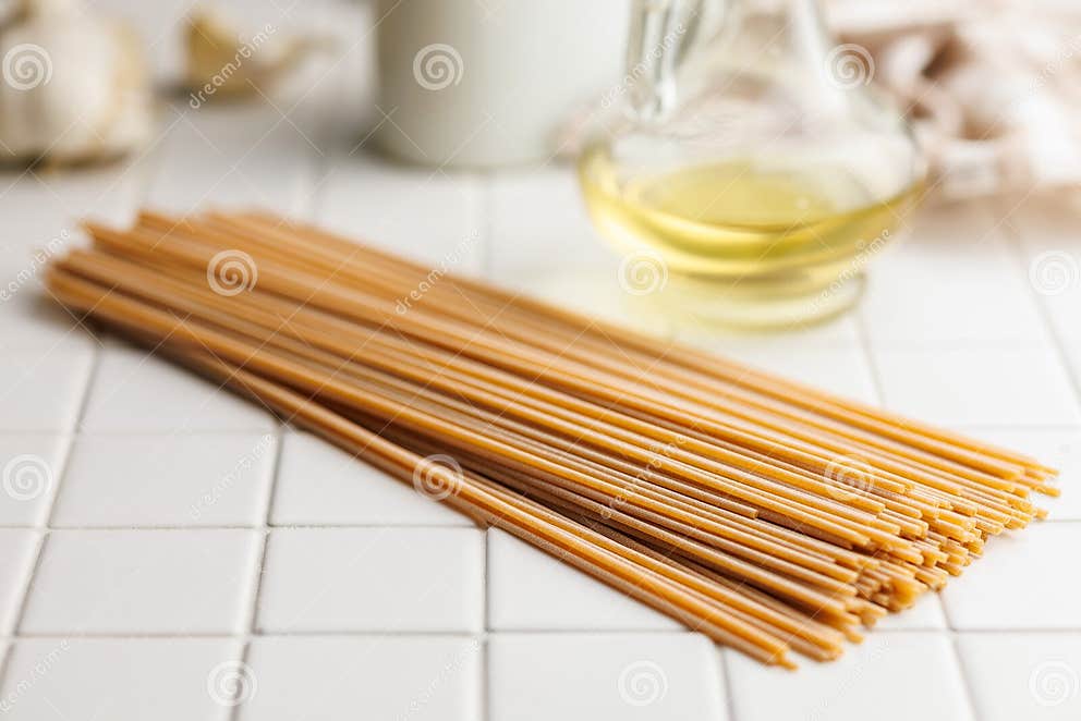 Uncooked Whole Grain Pasta. Raw Spaghetti on Tile Table Stock Photo ...