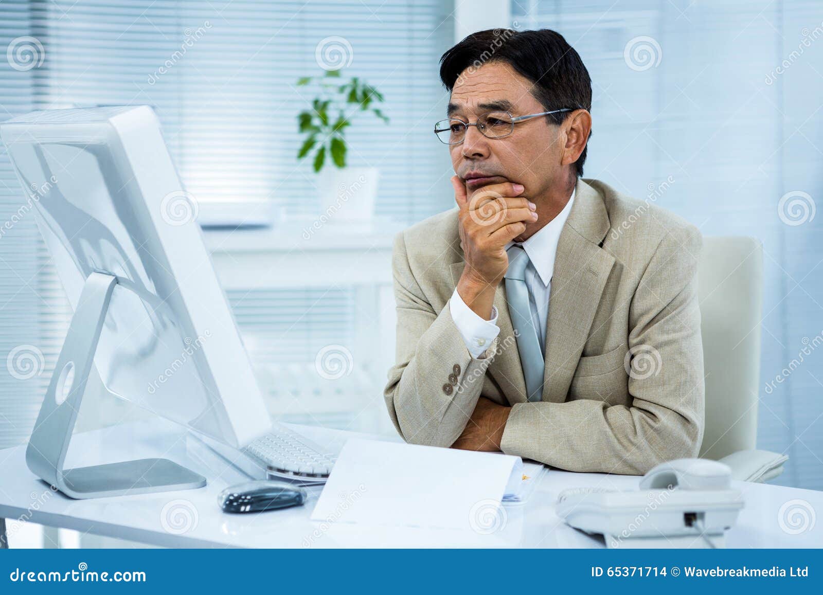 Undecided Businessman at His Computer Stock Photo - Image of quizzical ...