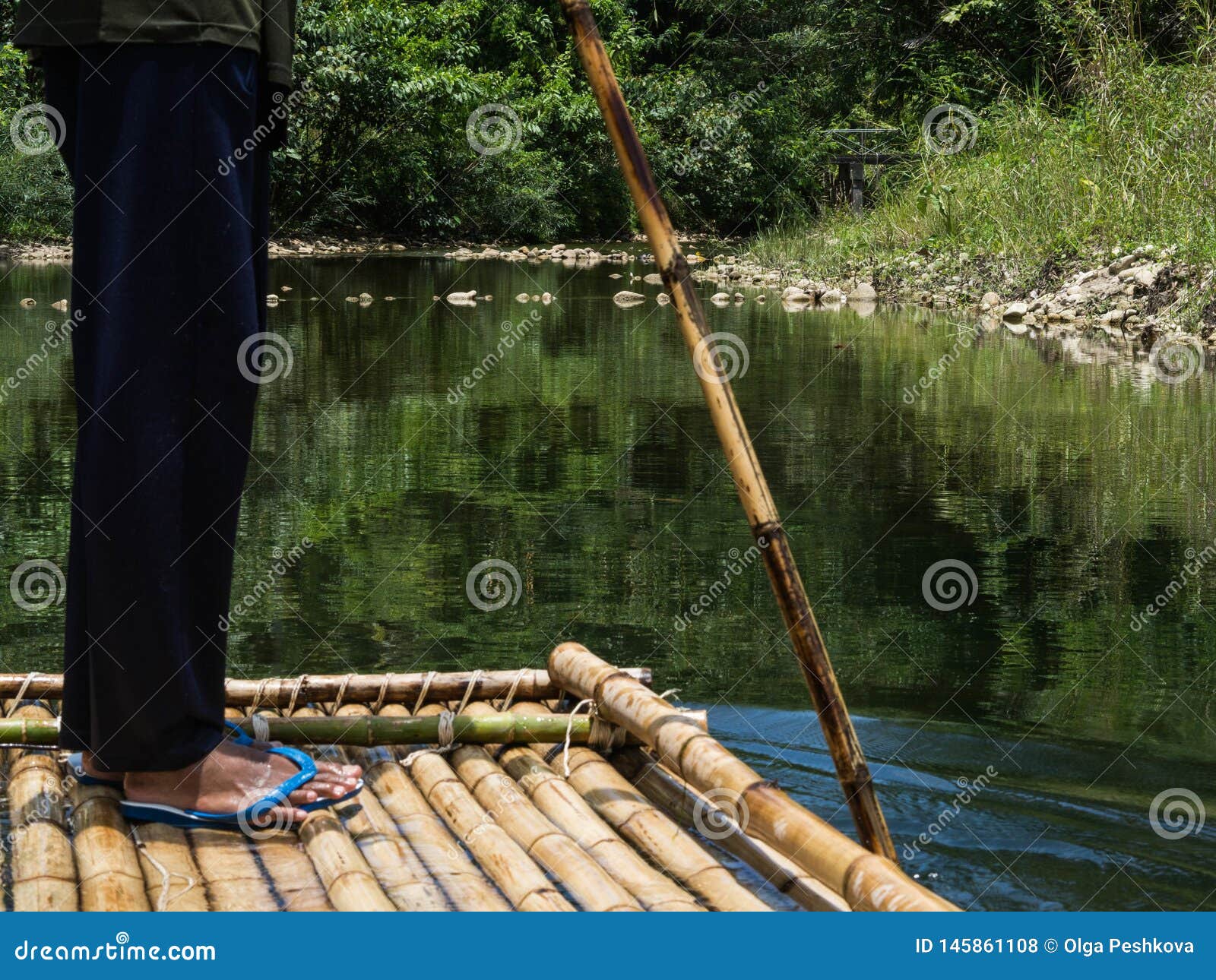 Undefined Man Drives a Makeshift Raft Sailing Along a River in the ...