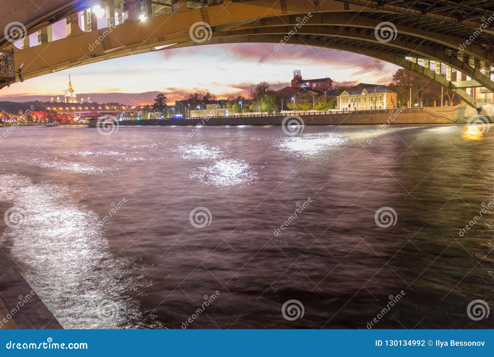 Under the Bridge Next To the River at Night You Can See the City. Stock ...