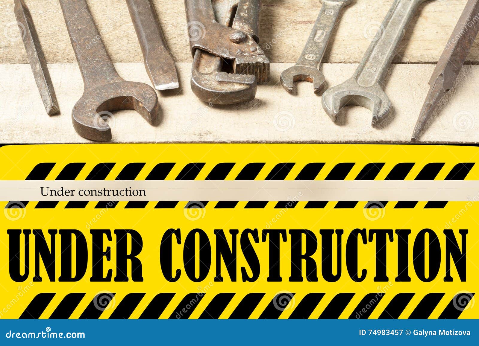 Under Construction Board with Repair Tools. Wrench on Wooden Background ...