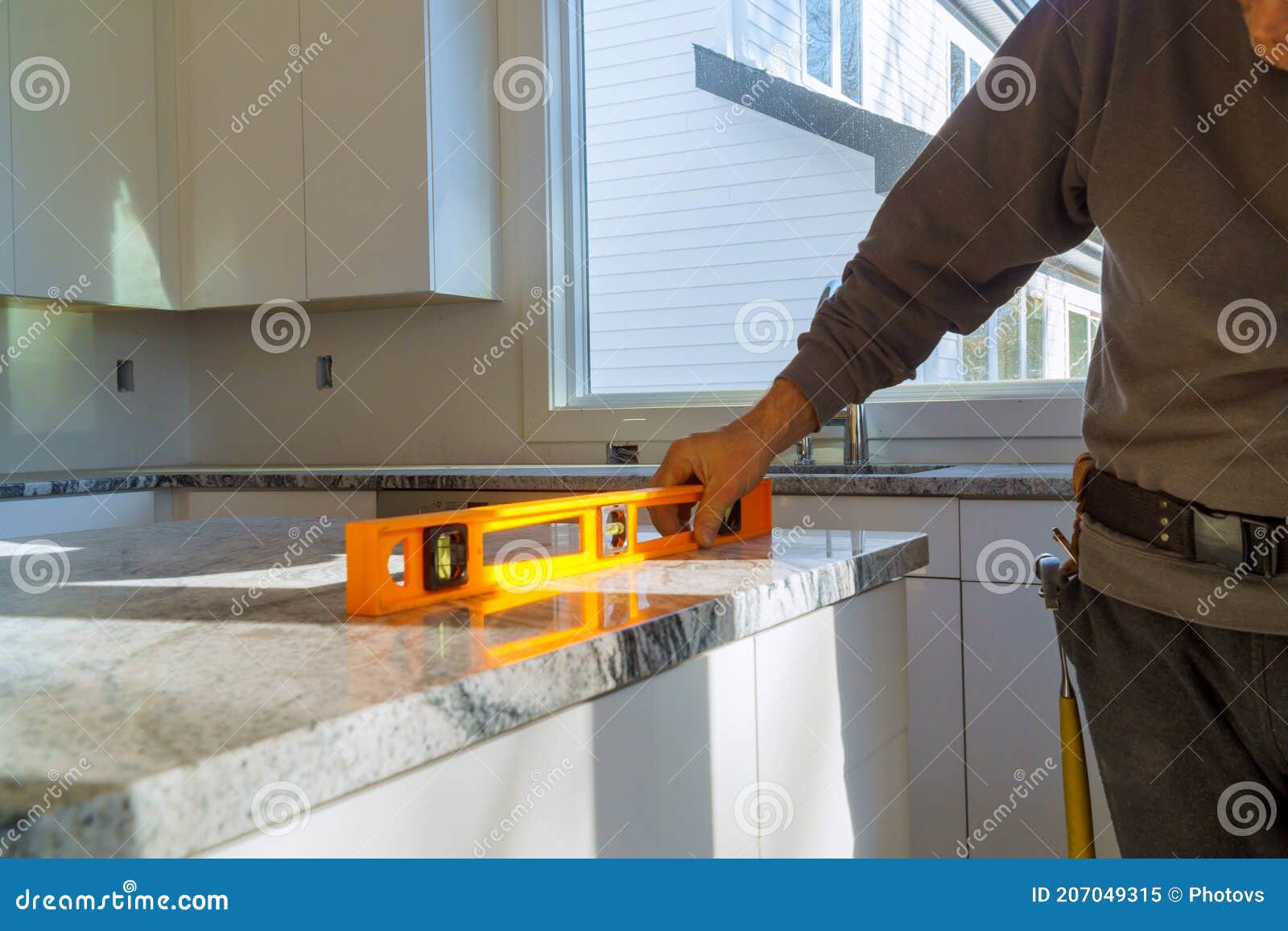 Under Construction with Worker Checks the Leveling of a Granite Slab ...