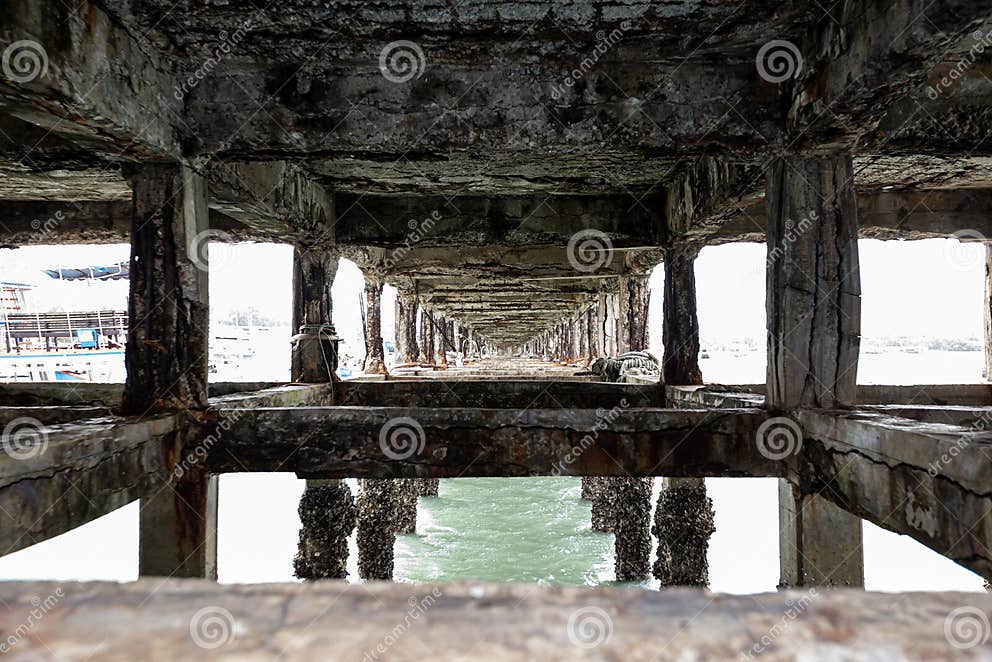Under the pier by the sea stock photo. Image of abandoned - 247829638