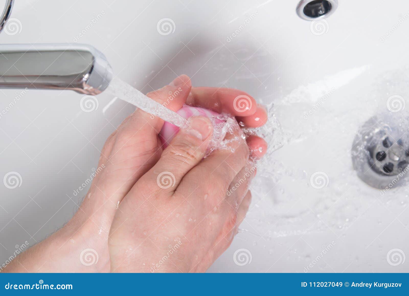 Under A Stream Of Water With Pink Soap Hands Are Soaped Up Stock Image