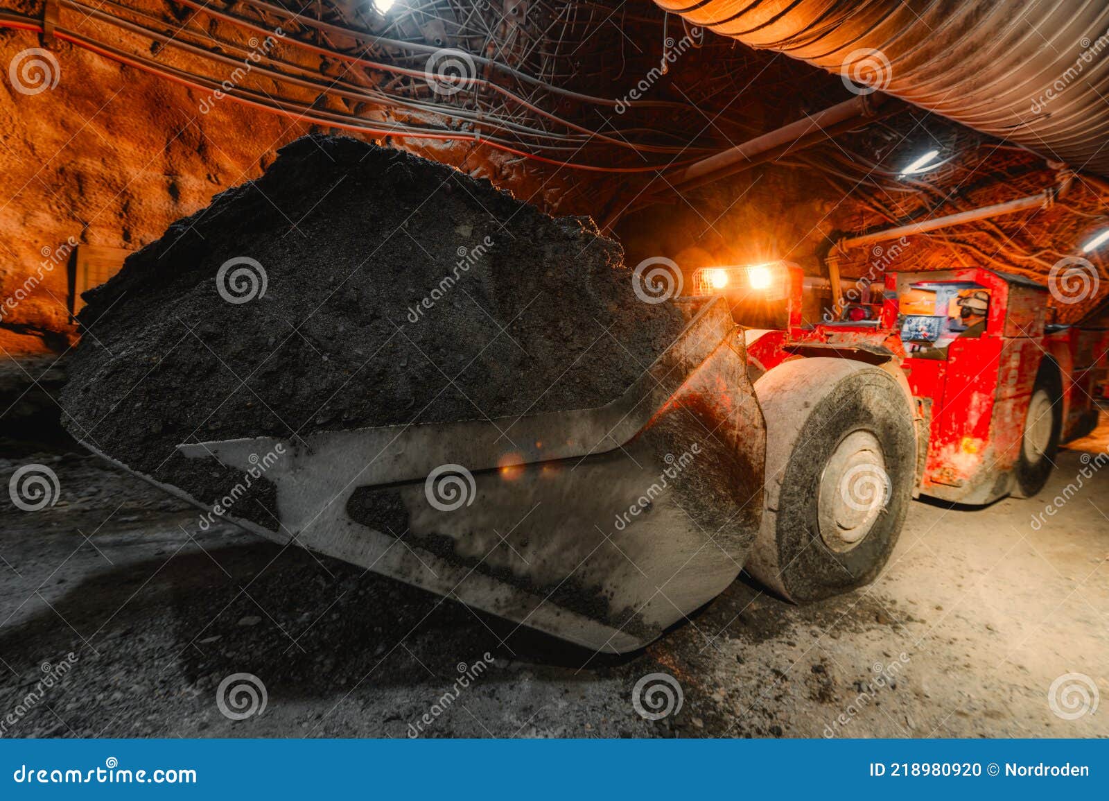 An Underground Loading Machine Carries a Full Bucket of Ore. Special ...