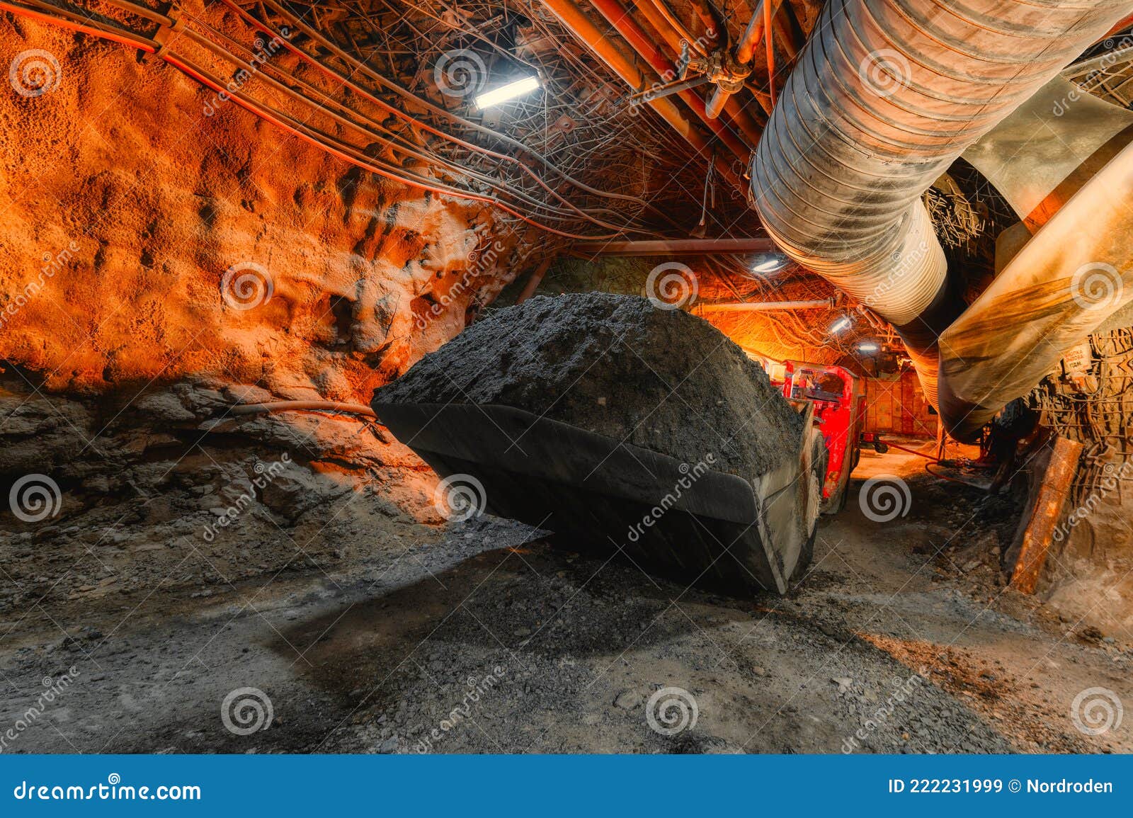 An Underground Loading Machine Carries a Full Bucket of Ore. Special ...