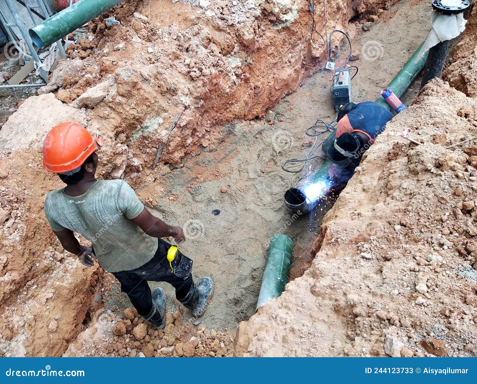 Underground Utility and Services Pipe Laid by Workers in the Trenches ...