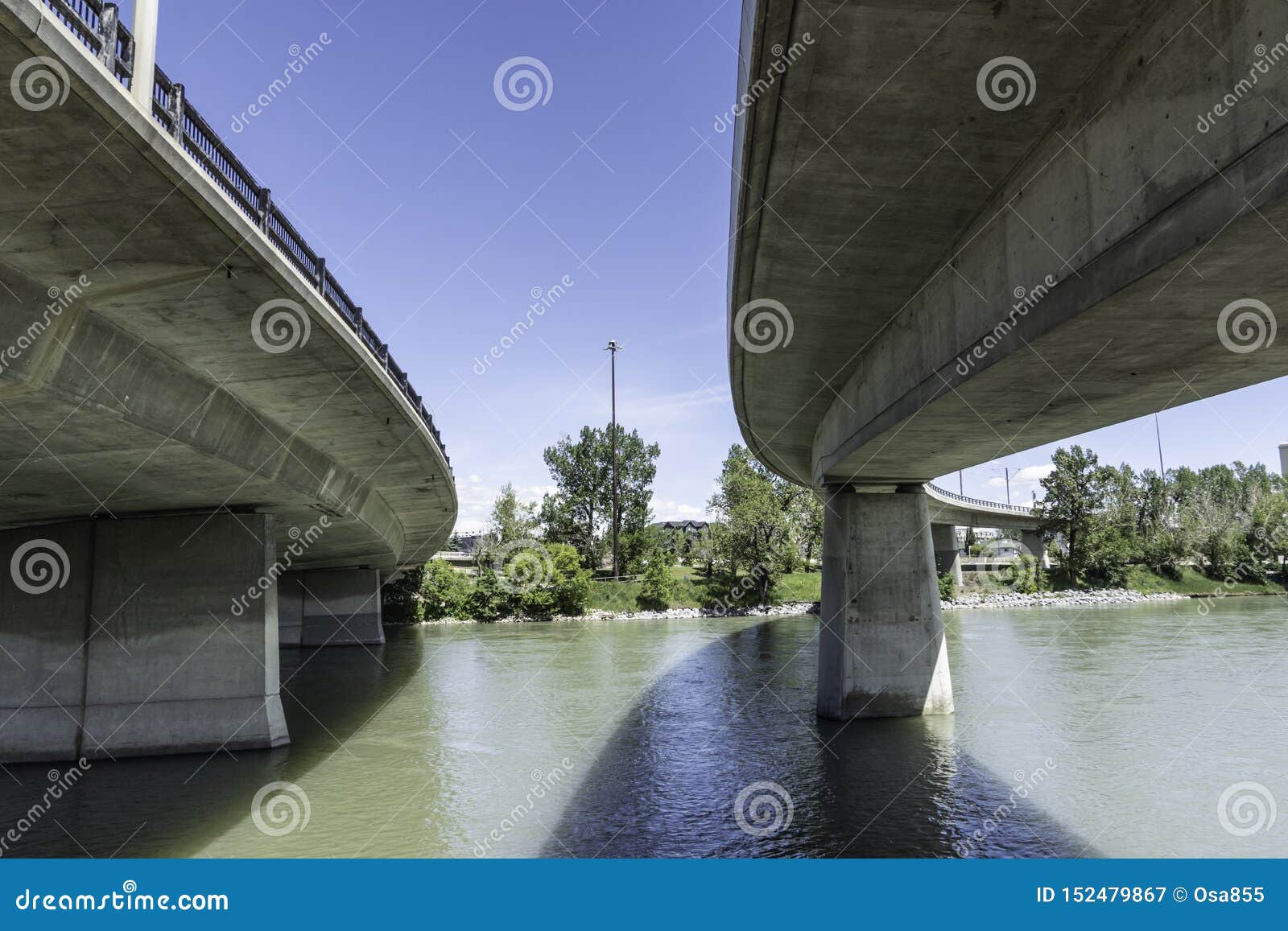 Underside of Bridges Crossing Over a River in City Stock Image - Image ...