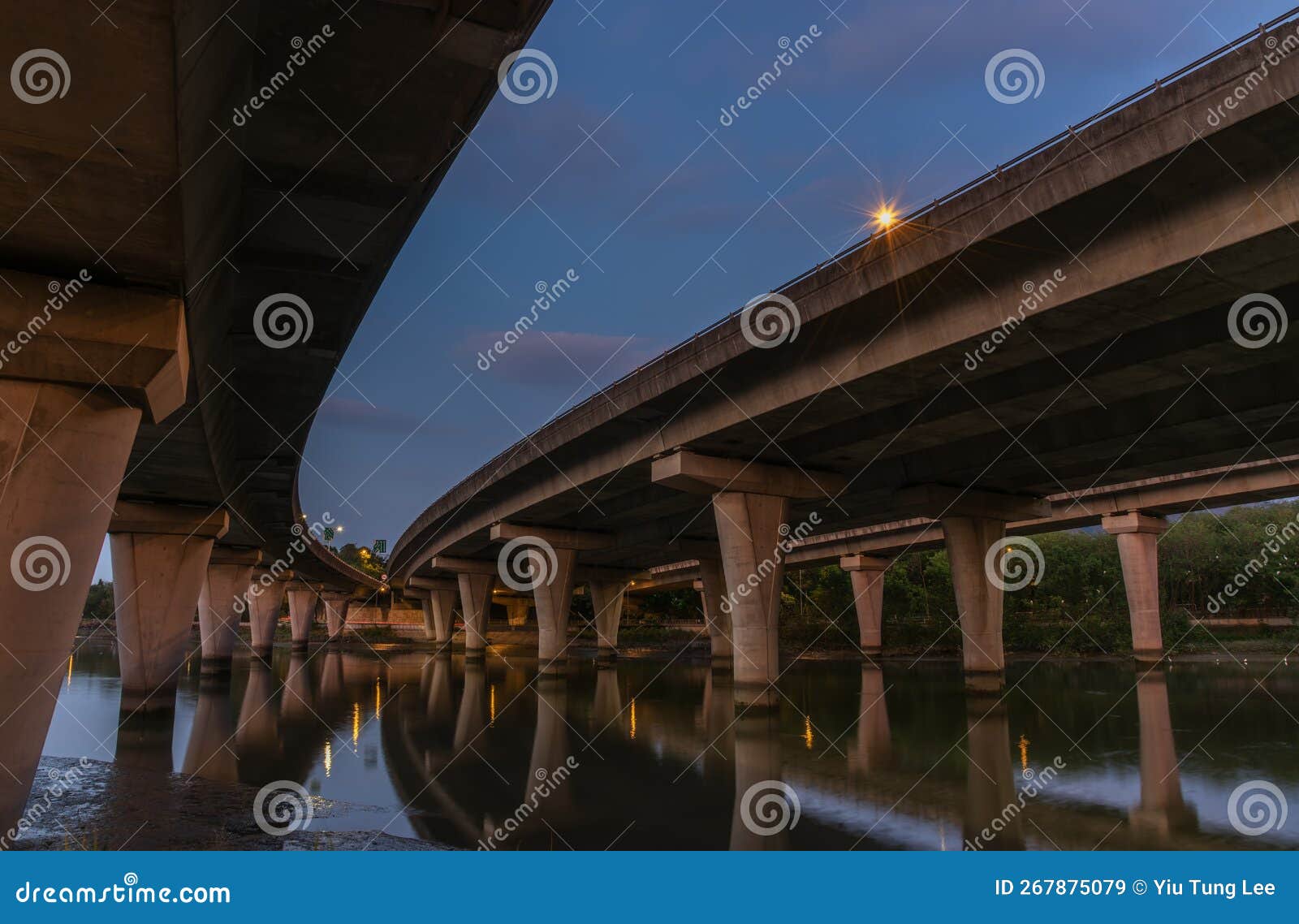 Underside of an Elevated Road Across River at Dusk Stock Image - Image ...