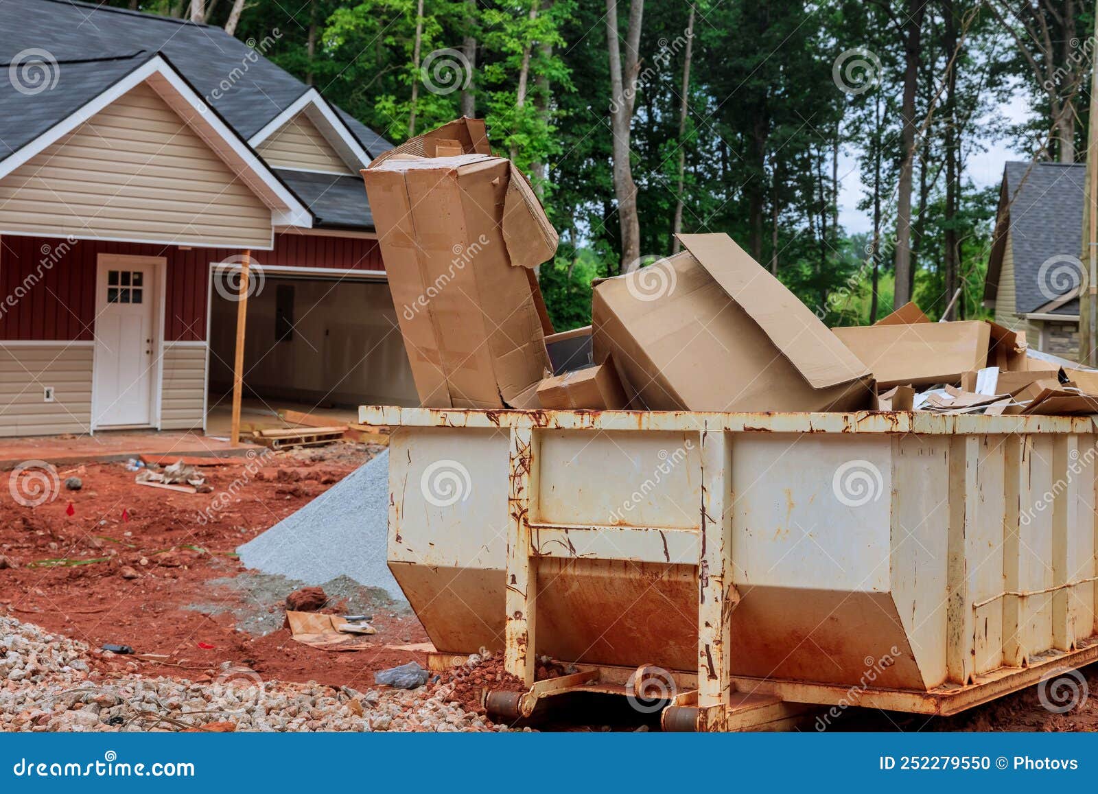 On the Underside of a House There is an Industrial Dumpster Full of ...