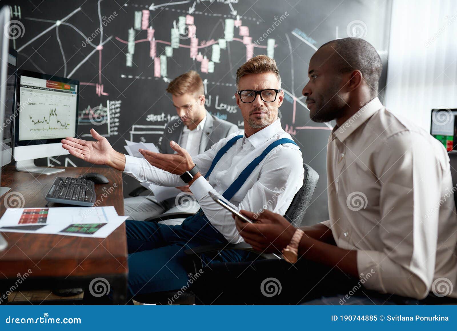 Understanding Commerce. Side View of Three Colleagues Traders Sitting ...