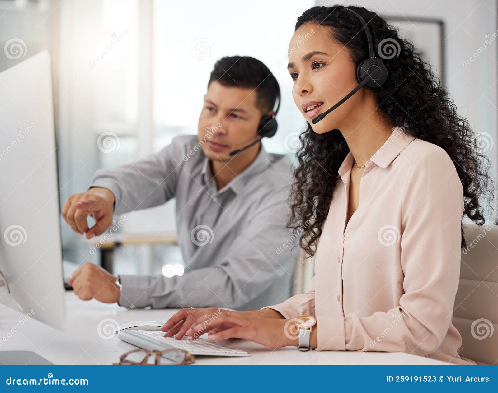 Understanding a Few New Processes. Two Call Centre Agents Working ...