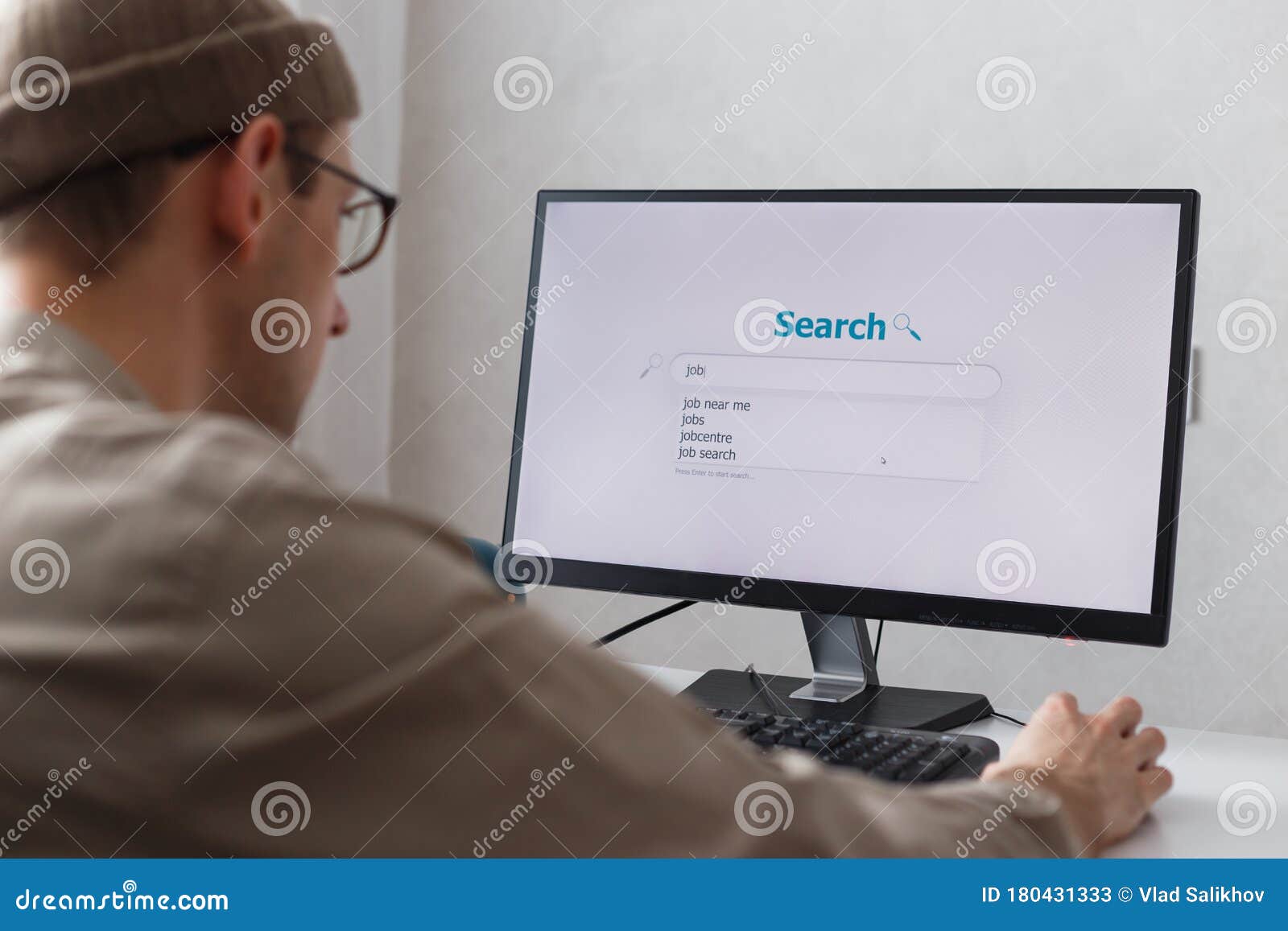 Unemployed Man Looking for Work on the Internet Sitting at the Computer ...