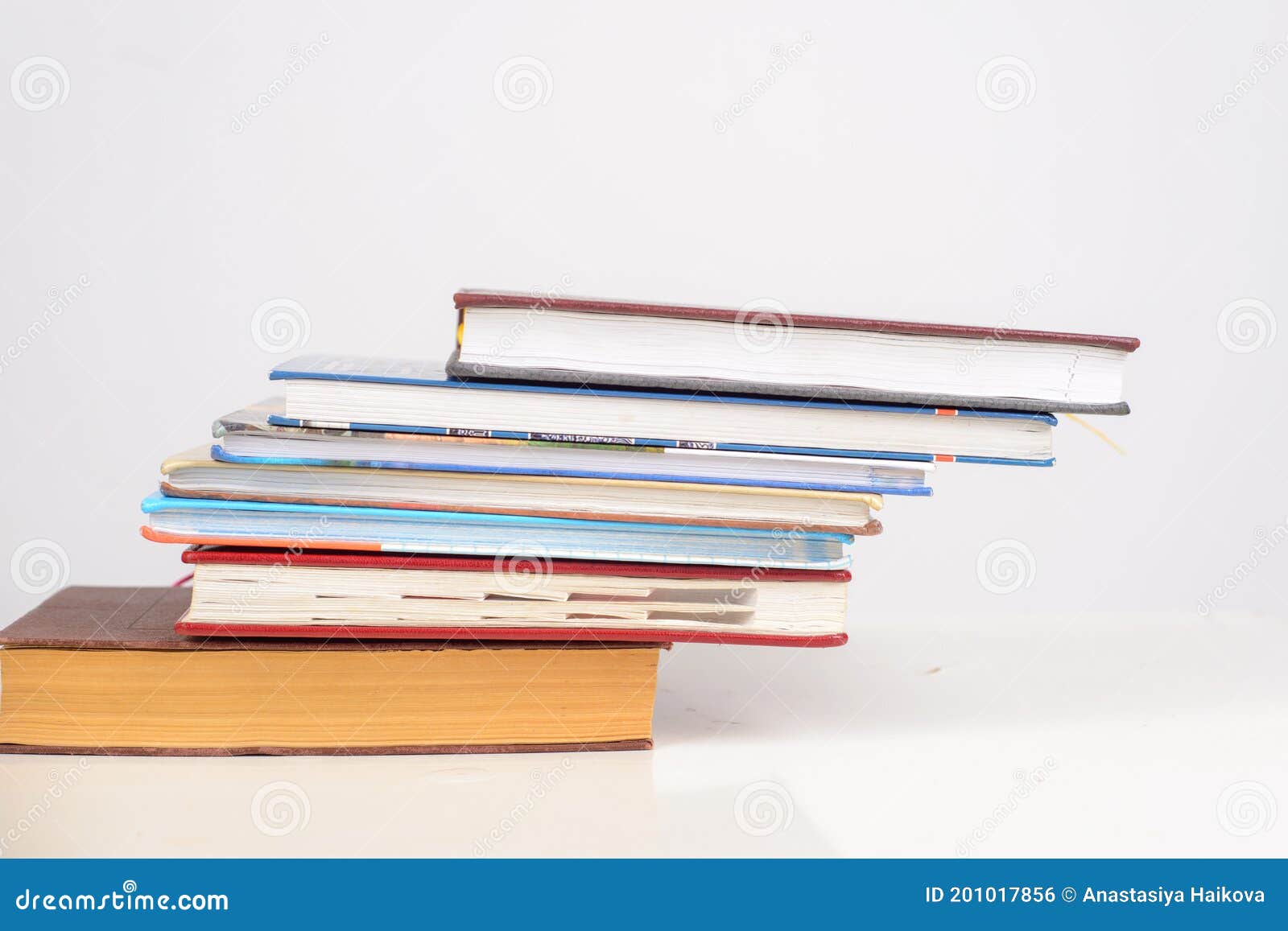 Uneven Stack of Colorful Books Lying on Table, Side View Stock Photo ...