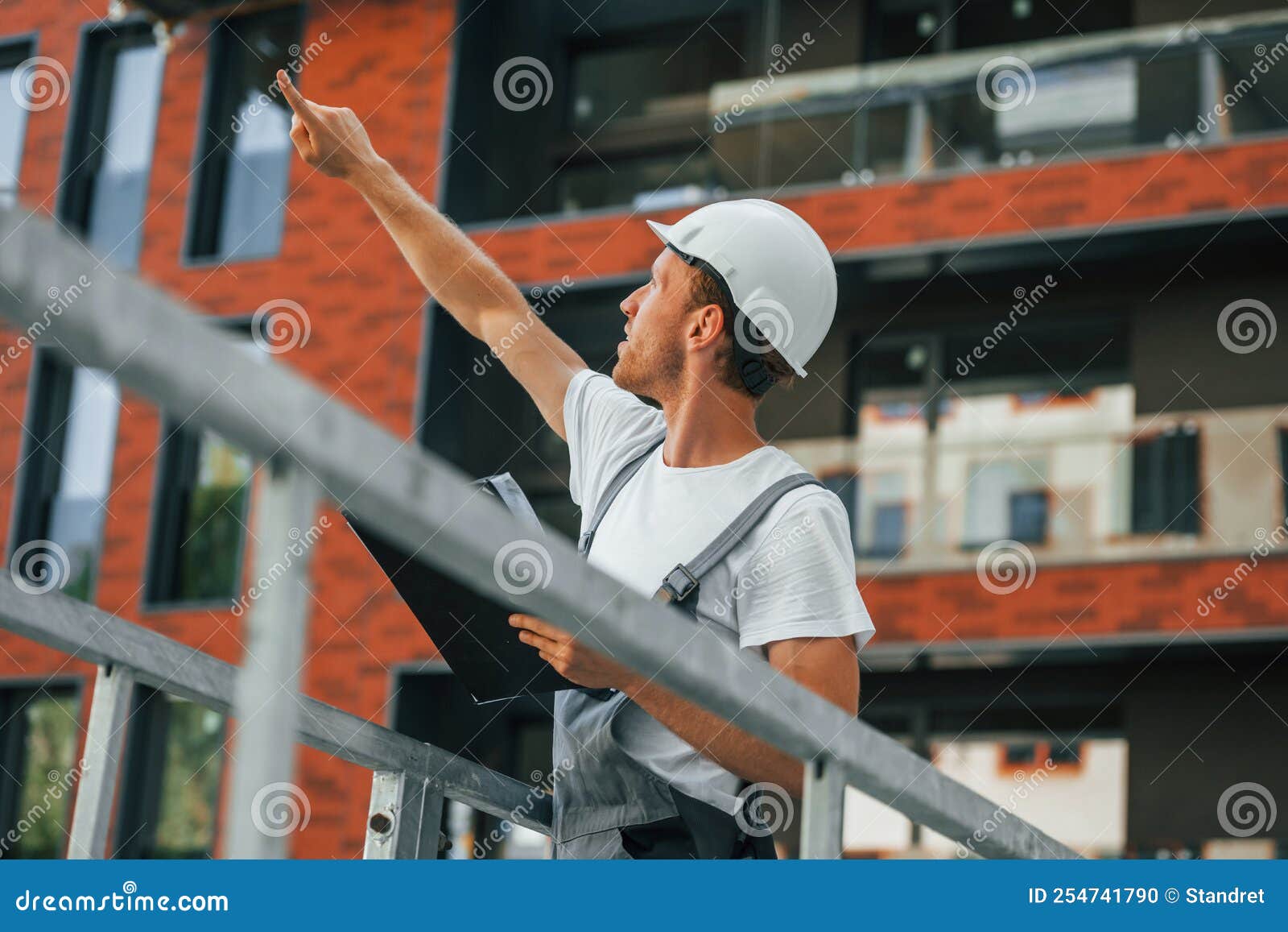 Unfinished Project. Young Man Working in Uniform at Construction at ...