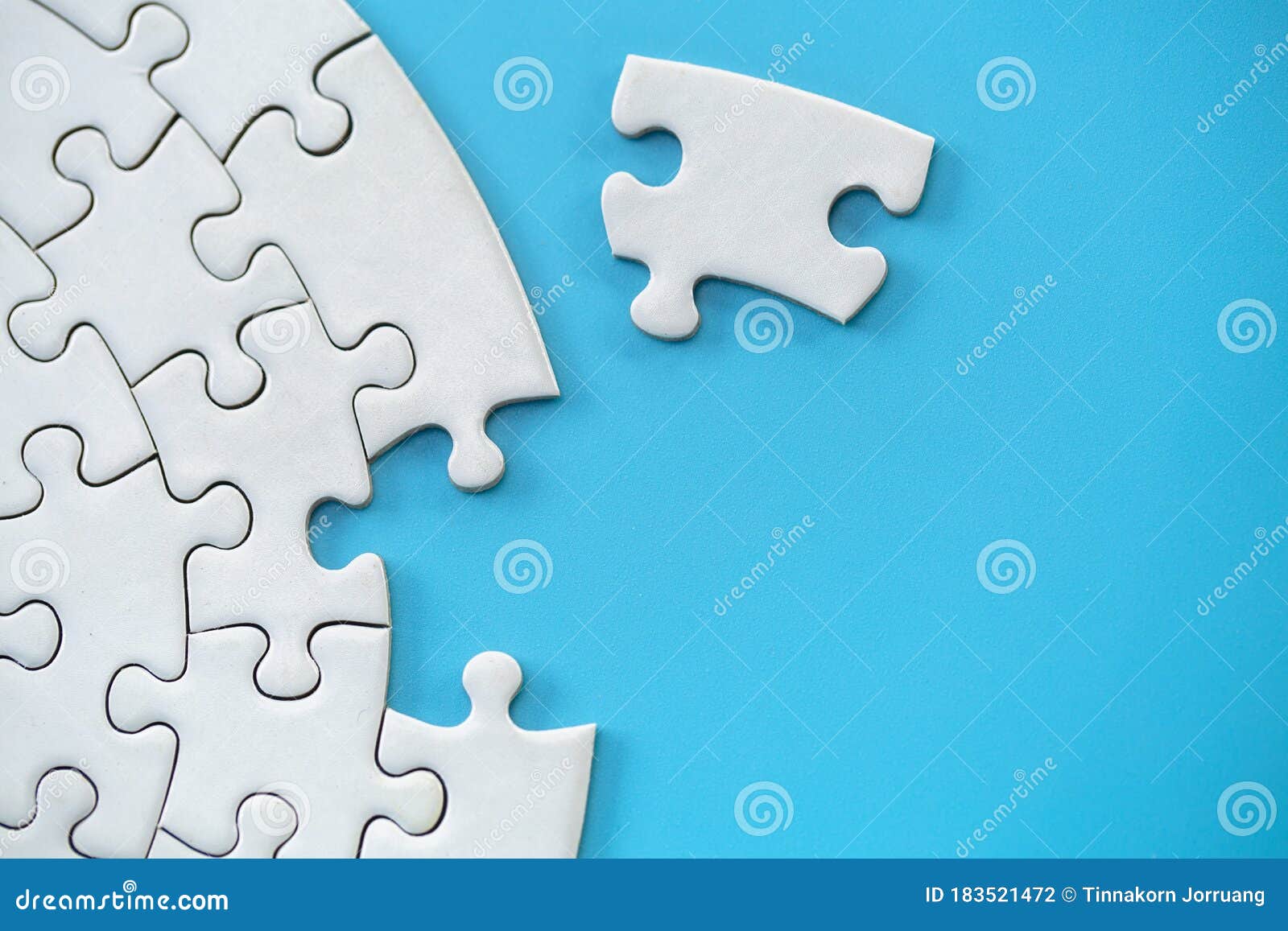 Unfinished White Jigsaw Puzzle on Blue Background with Copy Space ...