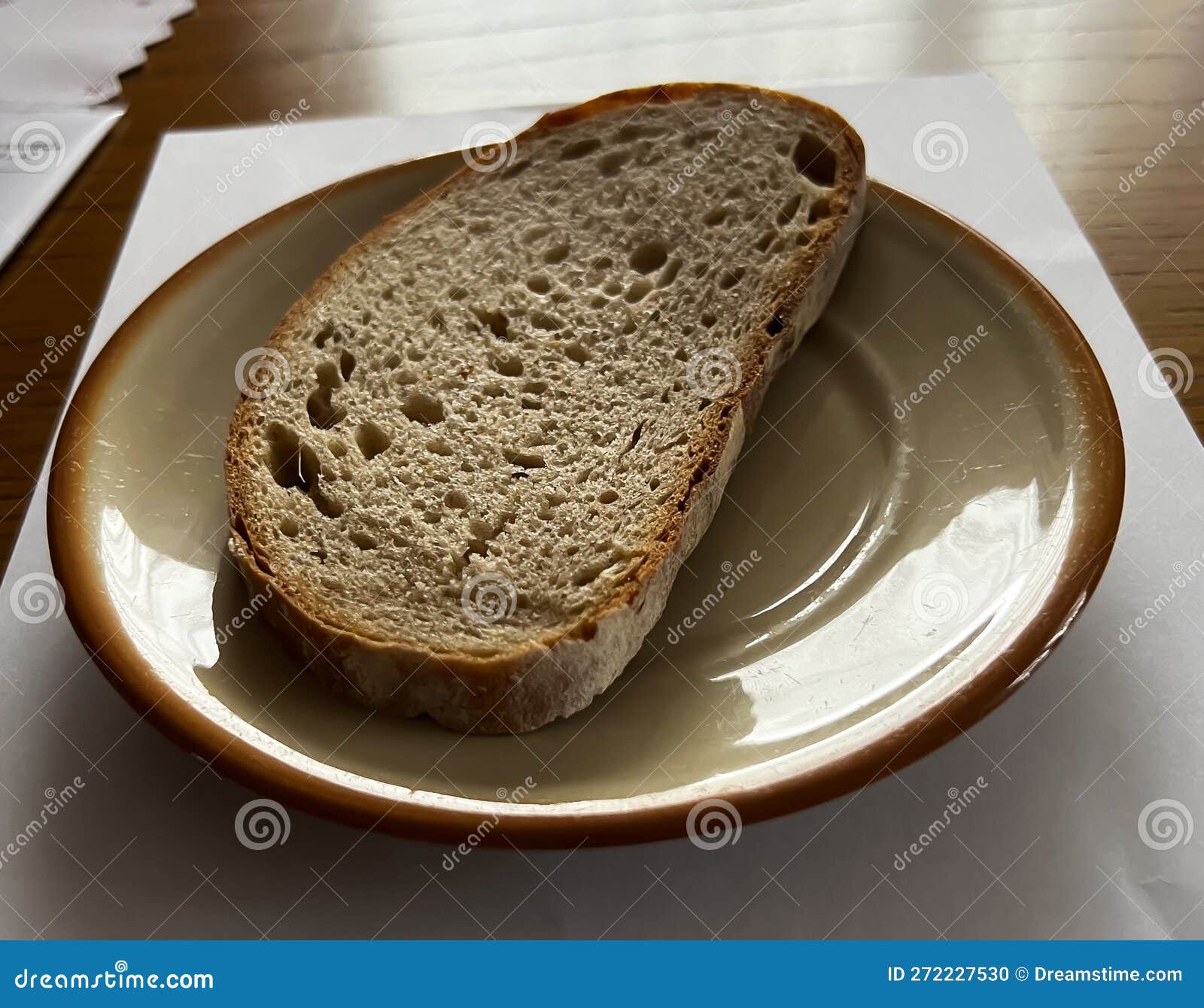 An Ungreased Slice of Bread Lying on a Faience Plate Stock Photo ...