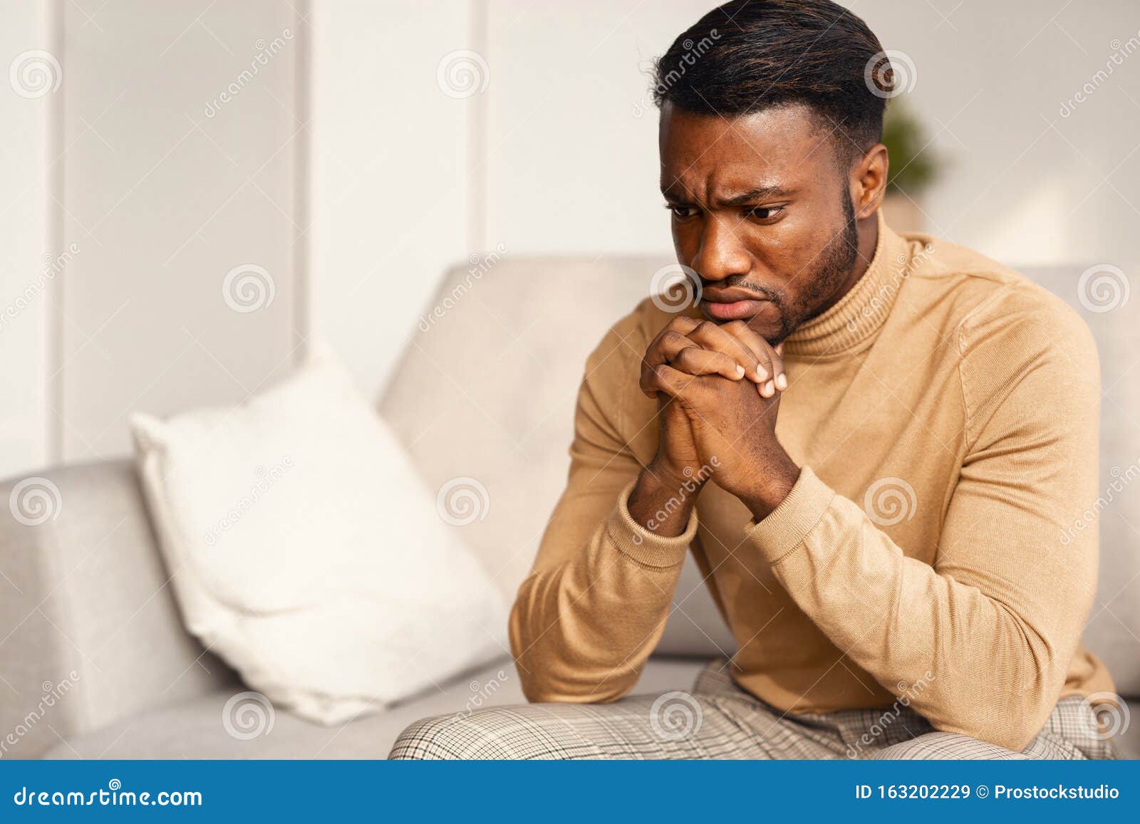 Unhappy Black Man Thinking Sitting on Couch at Home Stock Image - Image ...