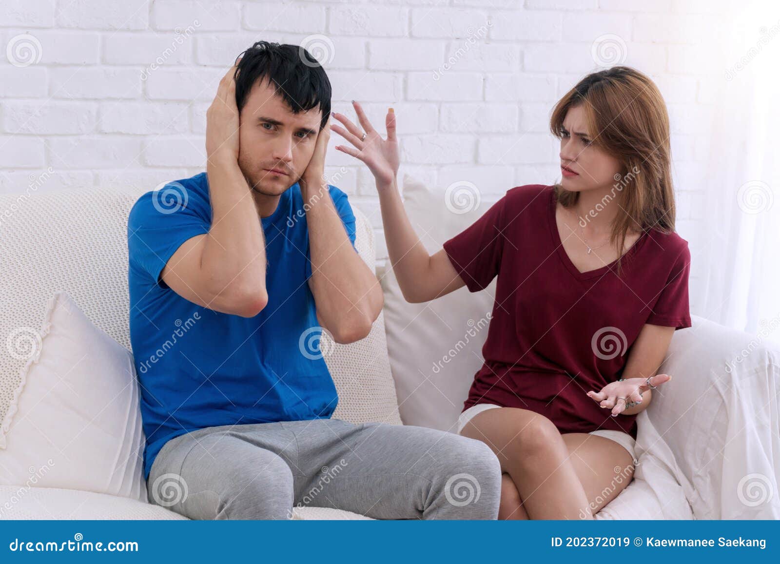 Unhappy Couples At Home Man And Beautiful Young Woman Are Sitting On