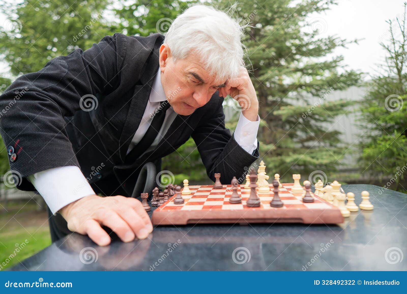 Unhappy Elderly Man Looking at Chessboard Outdoors. Stock Photo - Image ...