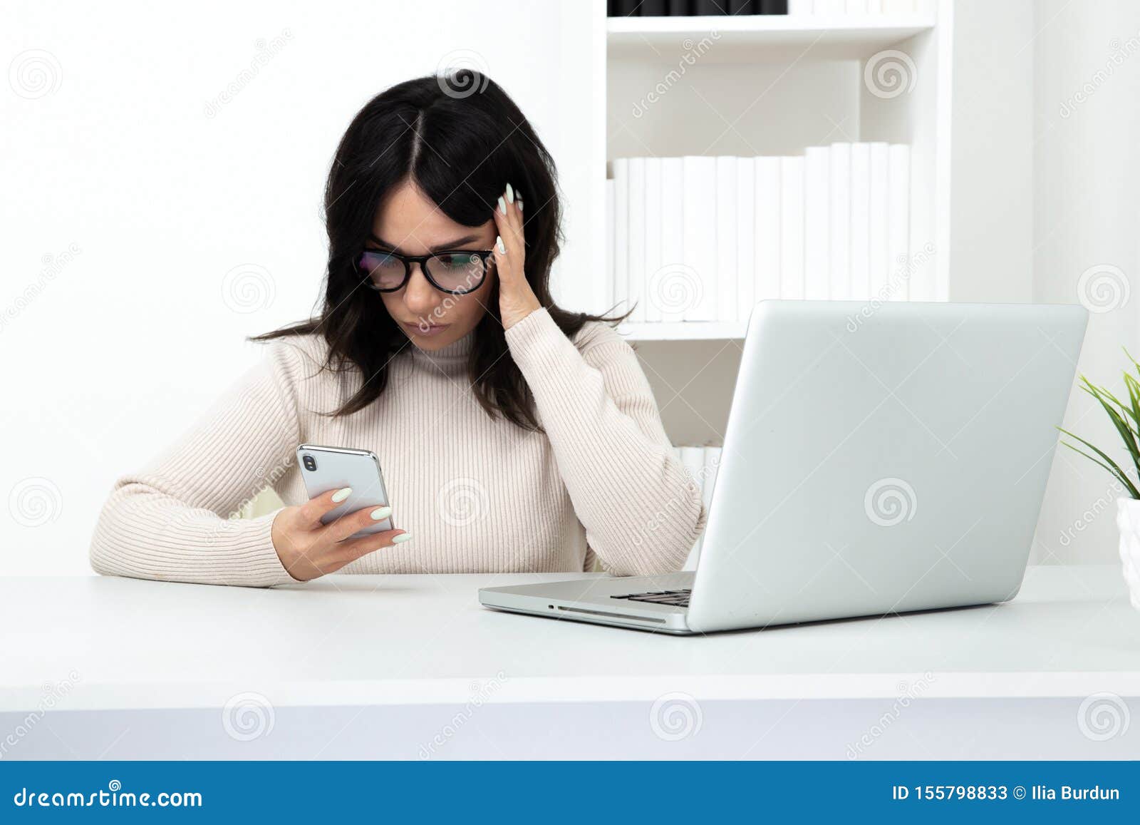 Unhappy and Frustrated Lady Watching Phone in Office Sitting Infront of ...