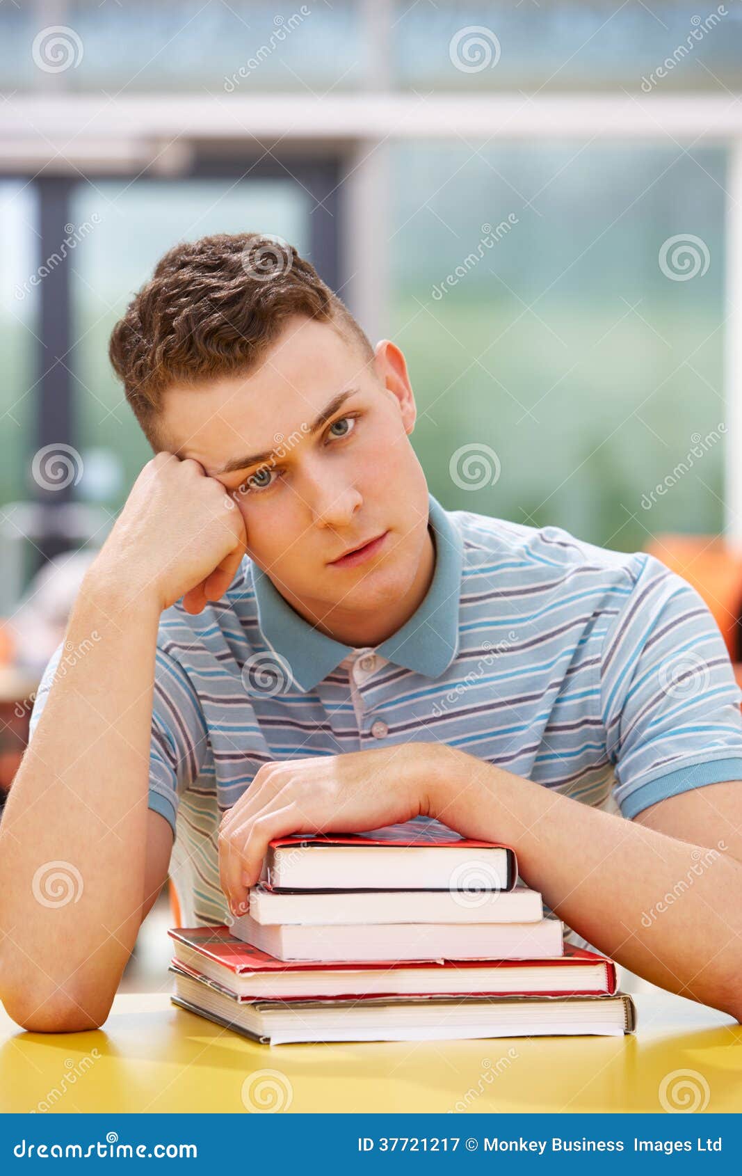 Unhappy Male Student Studying in Classroom with Books Stock Image ...