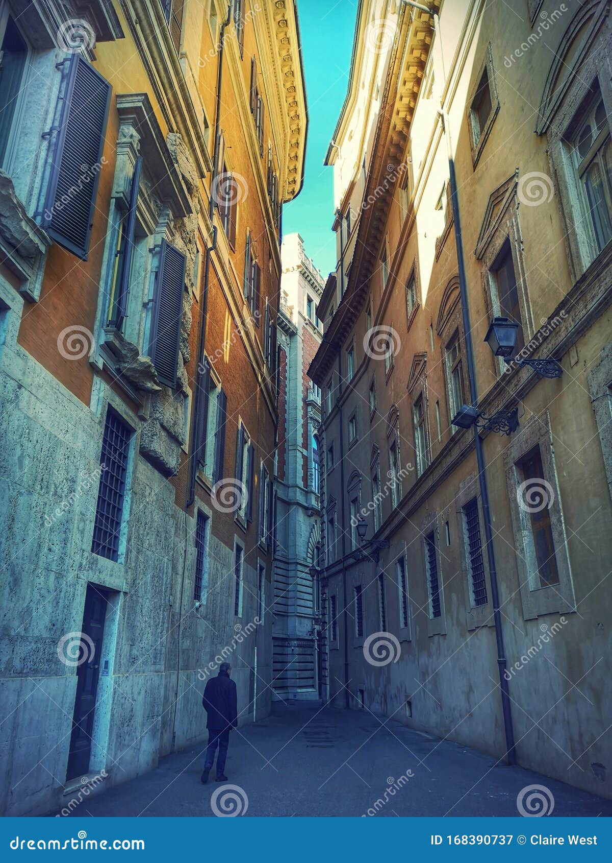 Unidentifiable Man Walks between Tall Buildings in Rome Stock Image ...