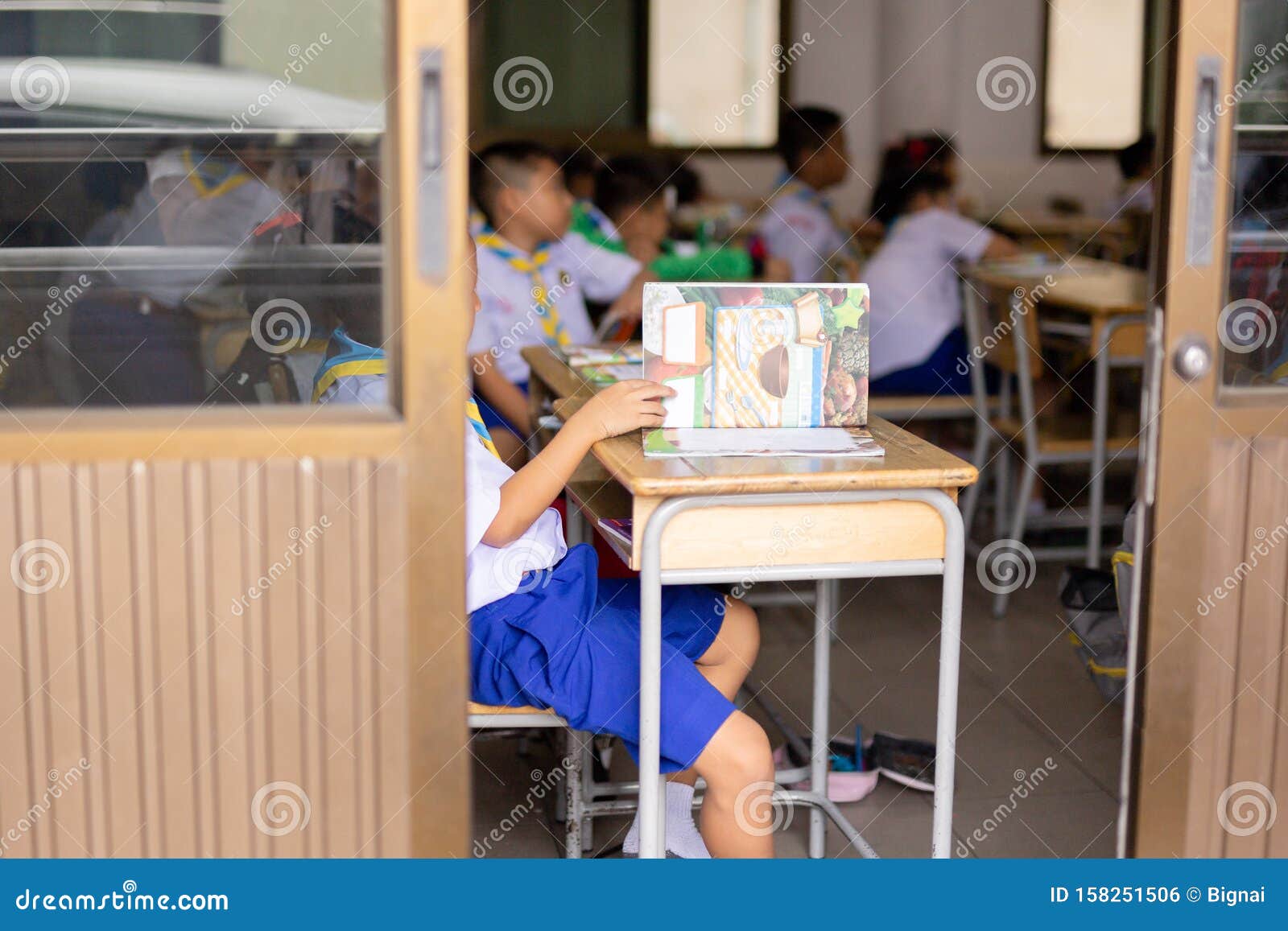 Unidentified Children Study in the Classroom with Open Book. Editorial ...
