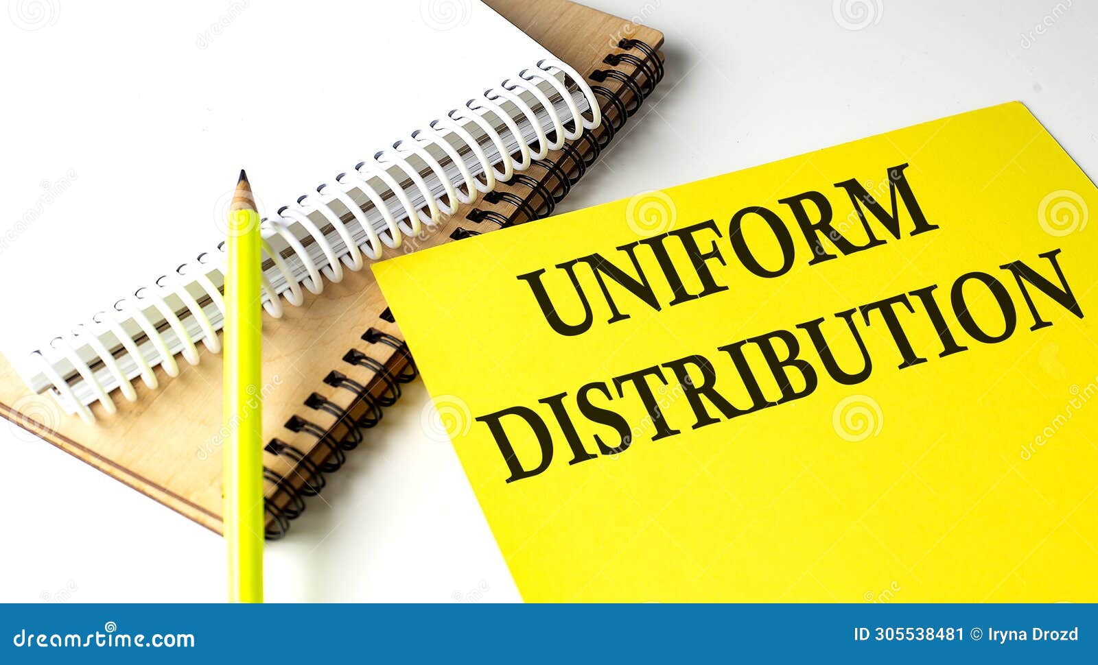 UNIFORM DISTRIBUTION Text Written on a Yellow Paper with Notebook Stock ...