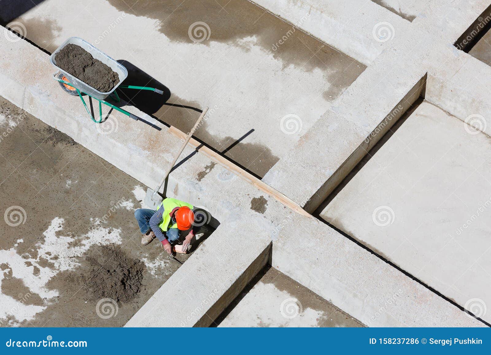 Uniformed Workers Clean Sand on a Construction Site, Top View Stock ...