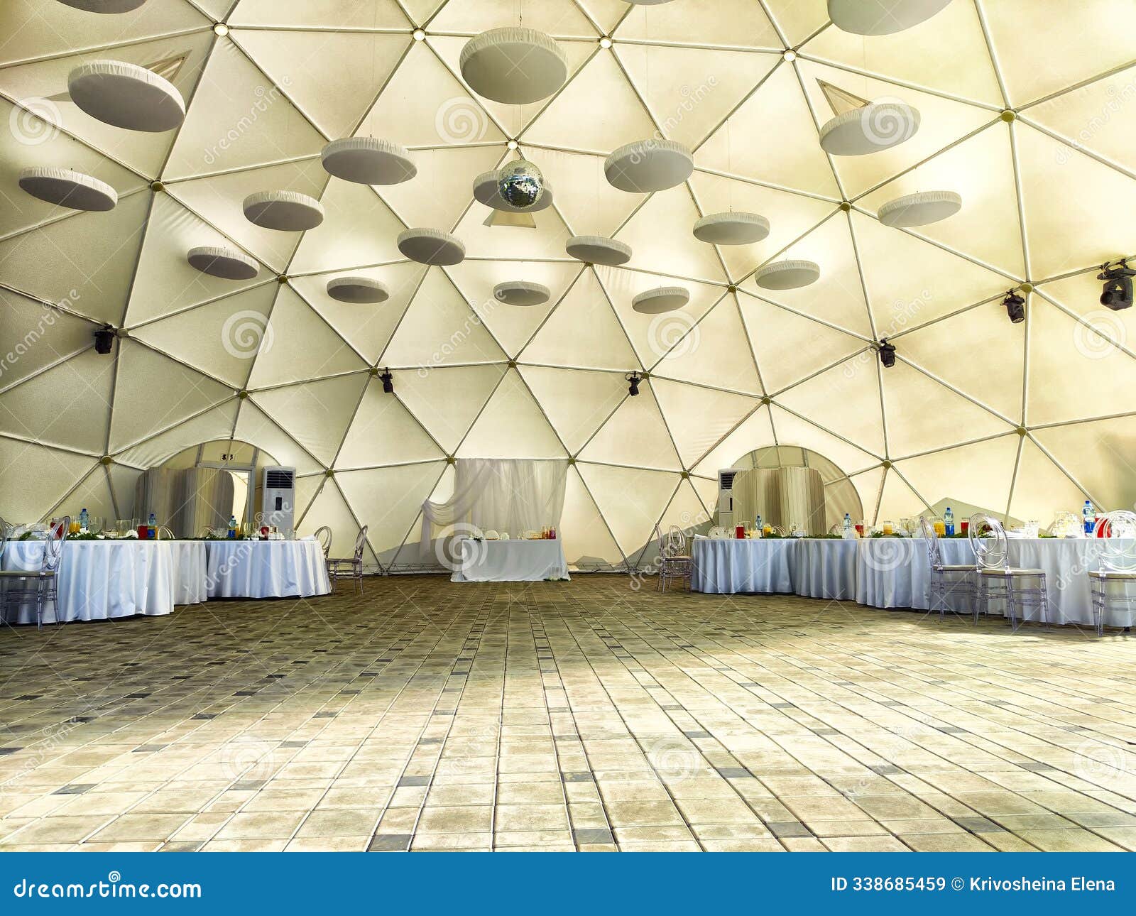 Unique Indoor Event Space Featuring Elegant Tables and a Disco Ball in ...