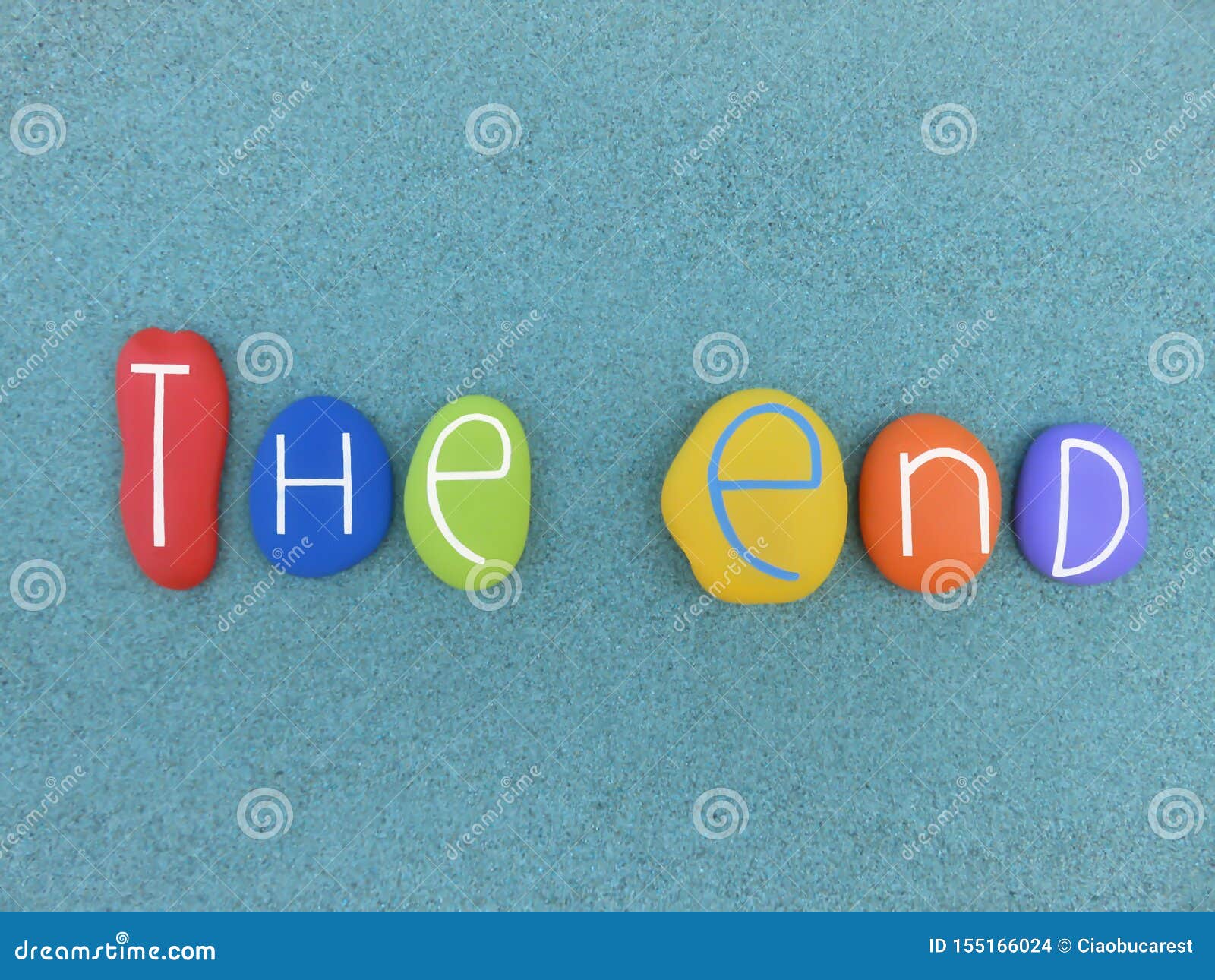 The End, Creative Text Composed with Colored Stone Letters Over Green ...