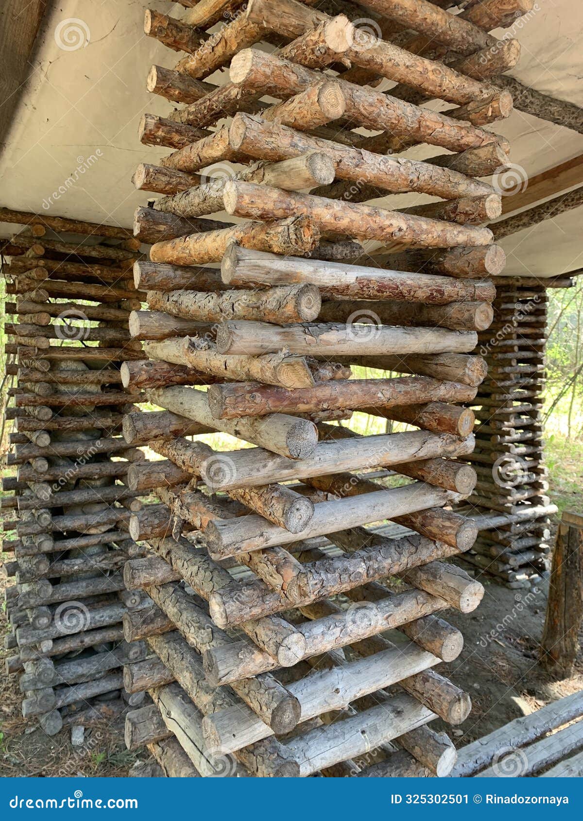 Unique Wooden Log Structure Resembling a Tower with Square Base and ...
