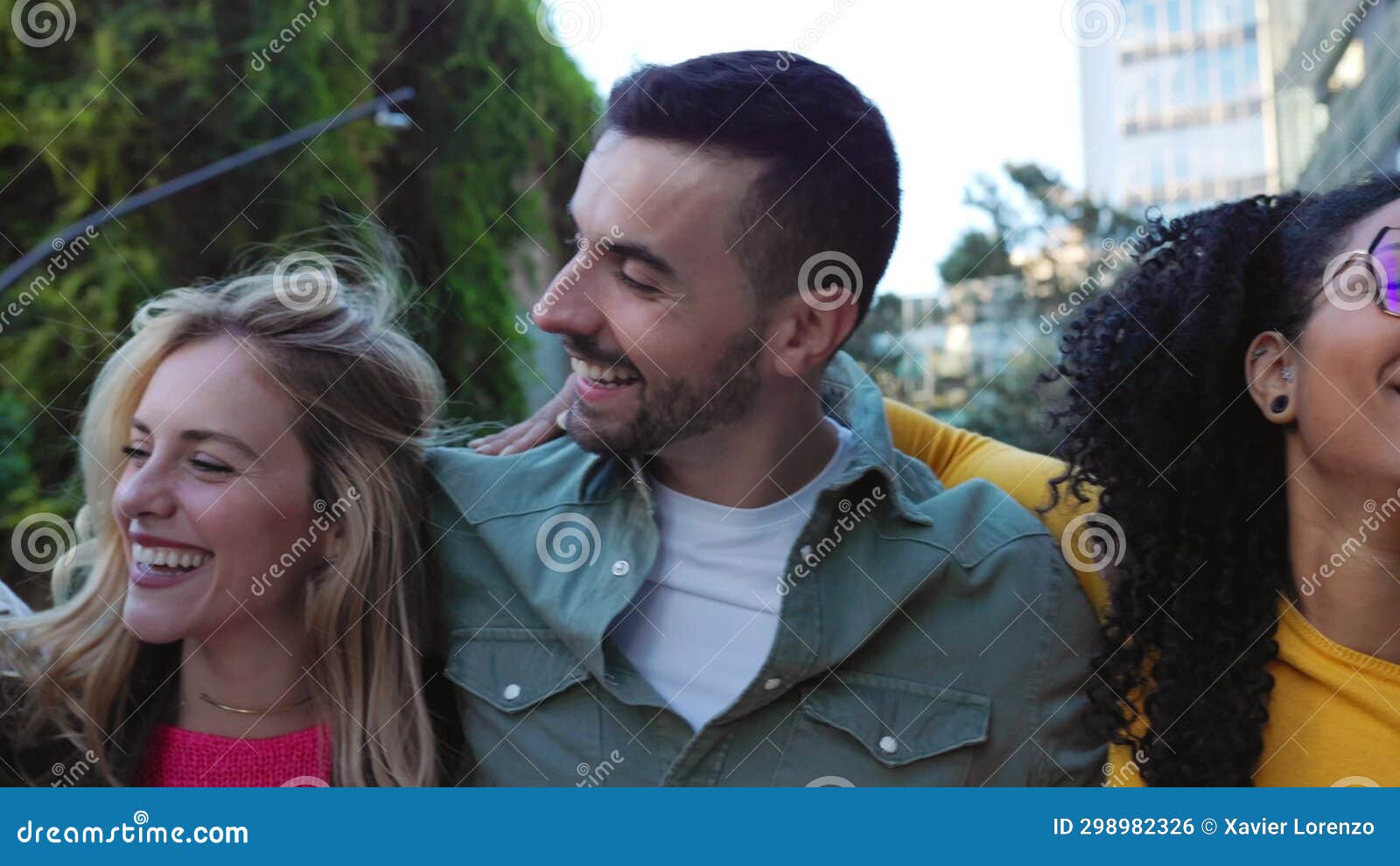 United Group Of Multiracial Friends Hugging Each Other Laughing