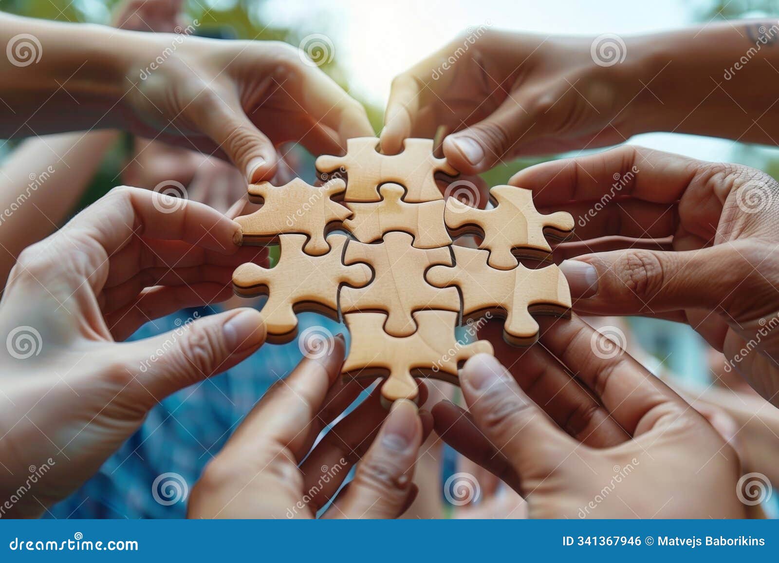 Unity in Teamwork Hands Holding Jigsaw Puzzle Pieces Against a Bright ...