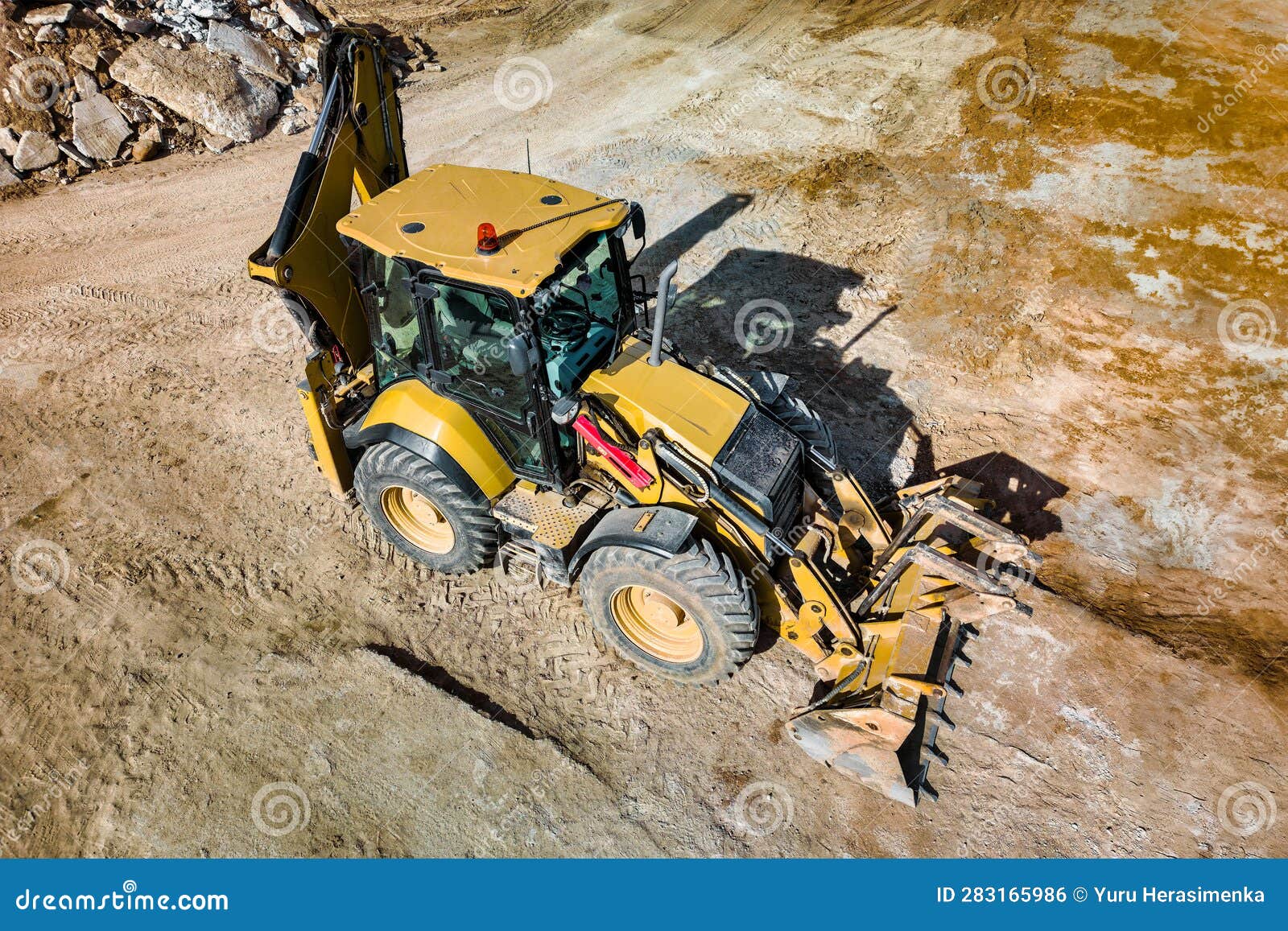 A Universal Excavator or Loader is Working on a Construction Site ...